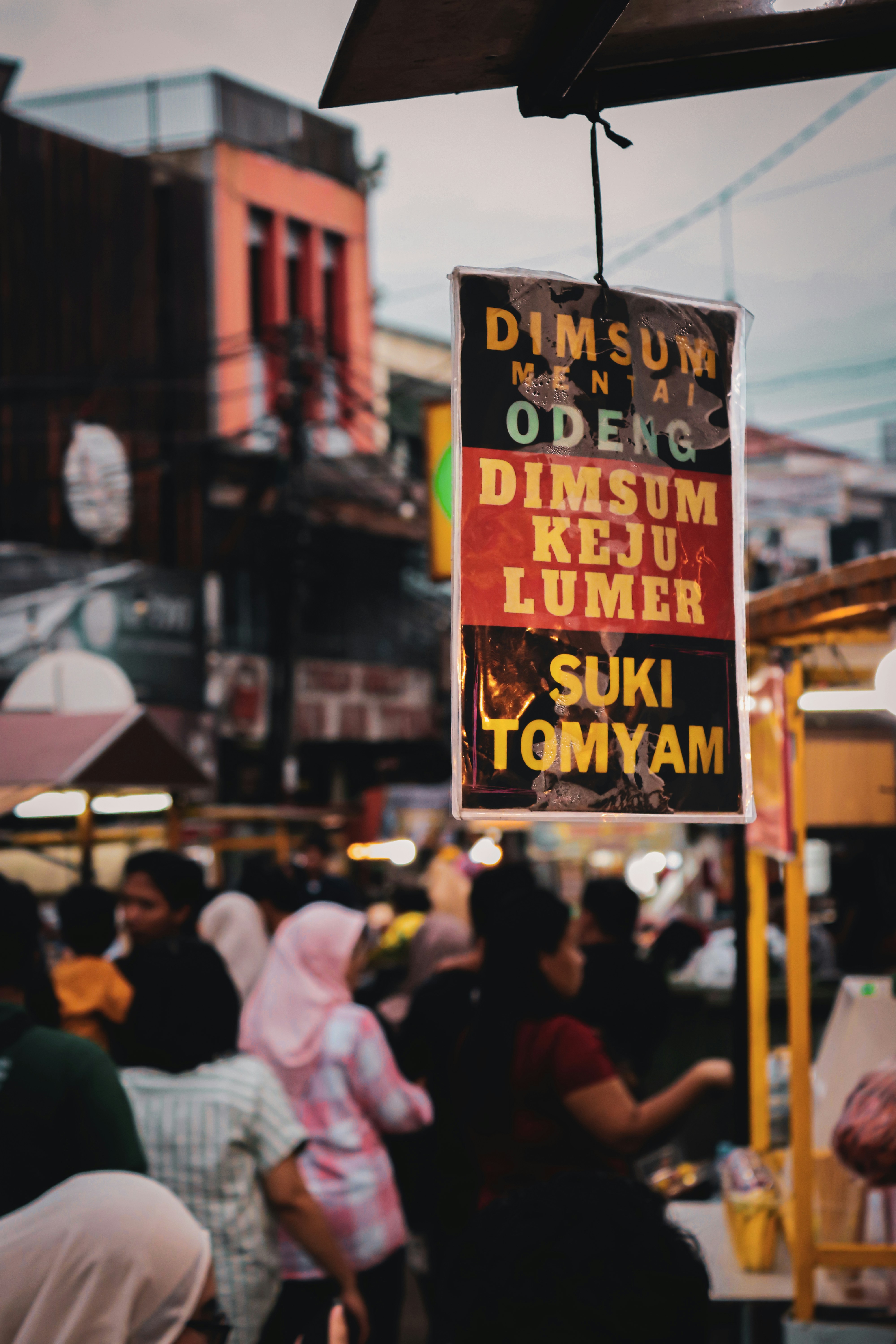 Vibrant Market Sign Amid a Crowd of Shoppers