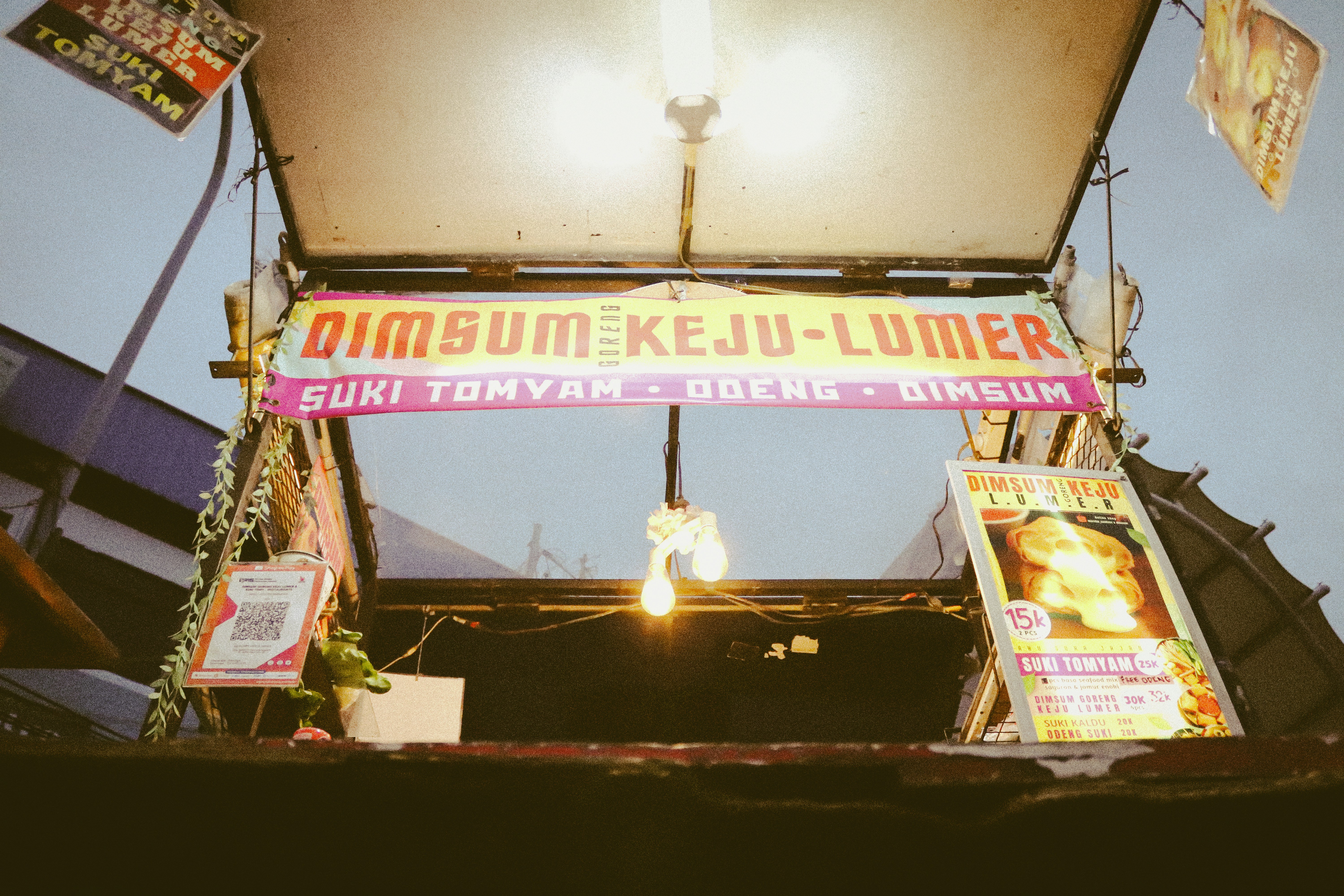 Neon-lit Food Stall Sign Across a Dim Market Entrance
