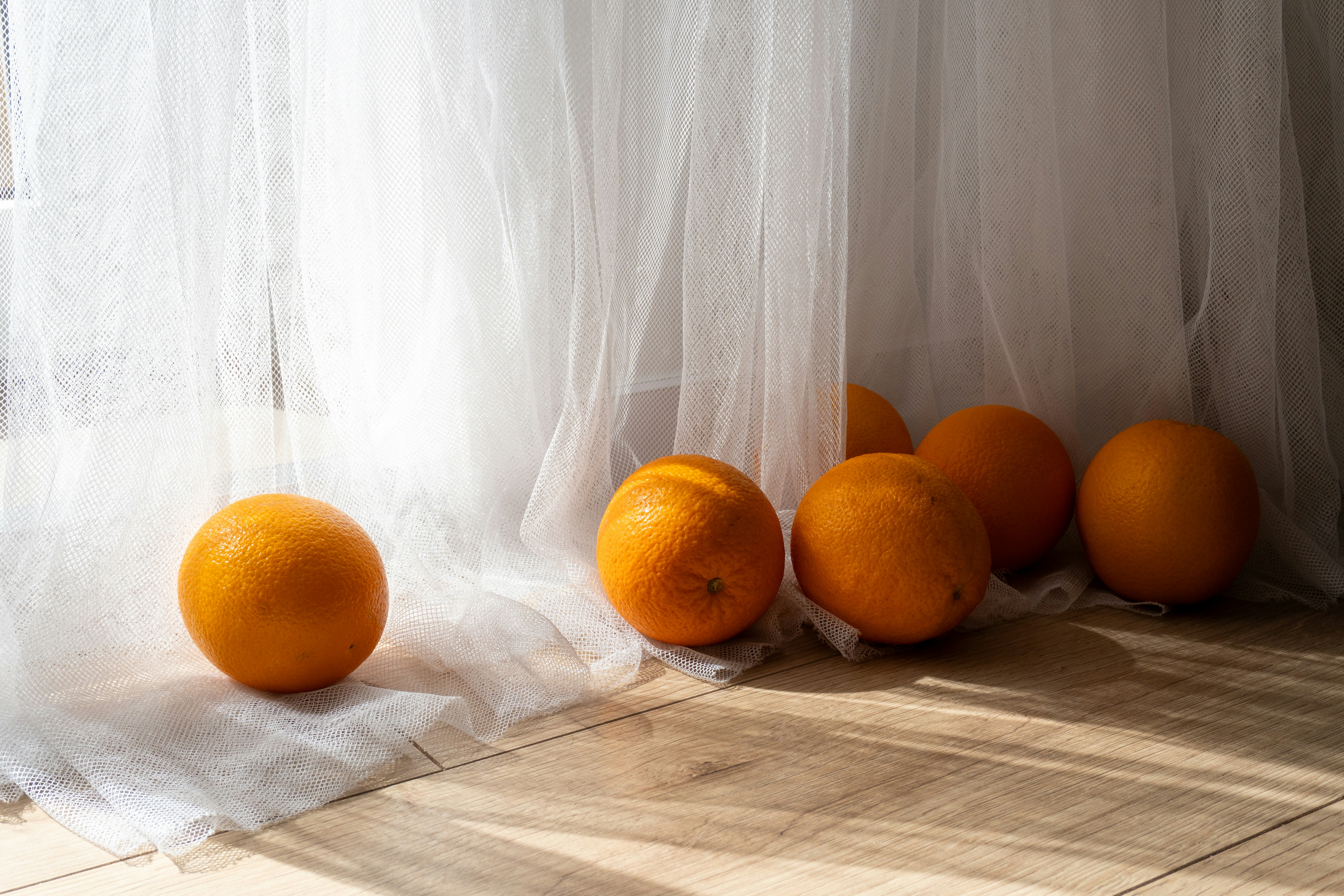 Orange Quartet Under Draped Veil on Sunlit Floor