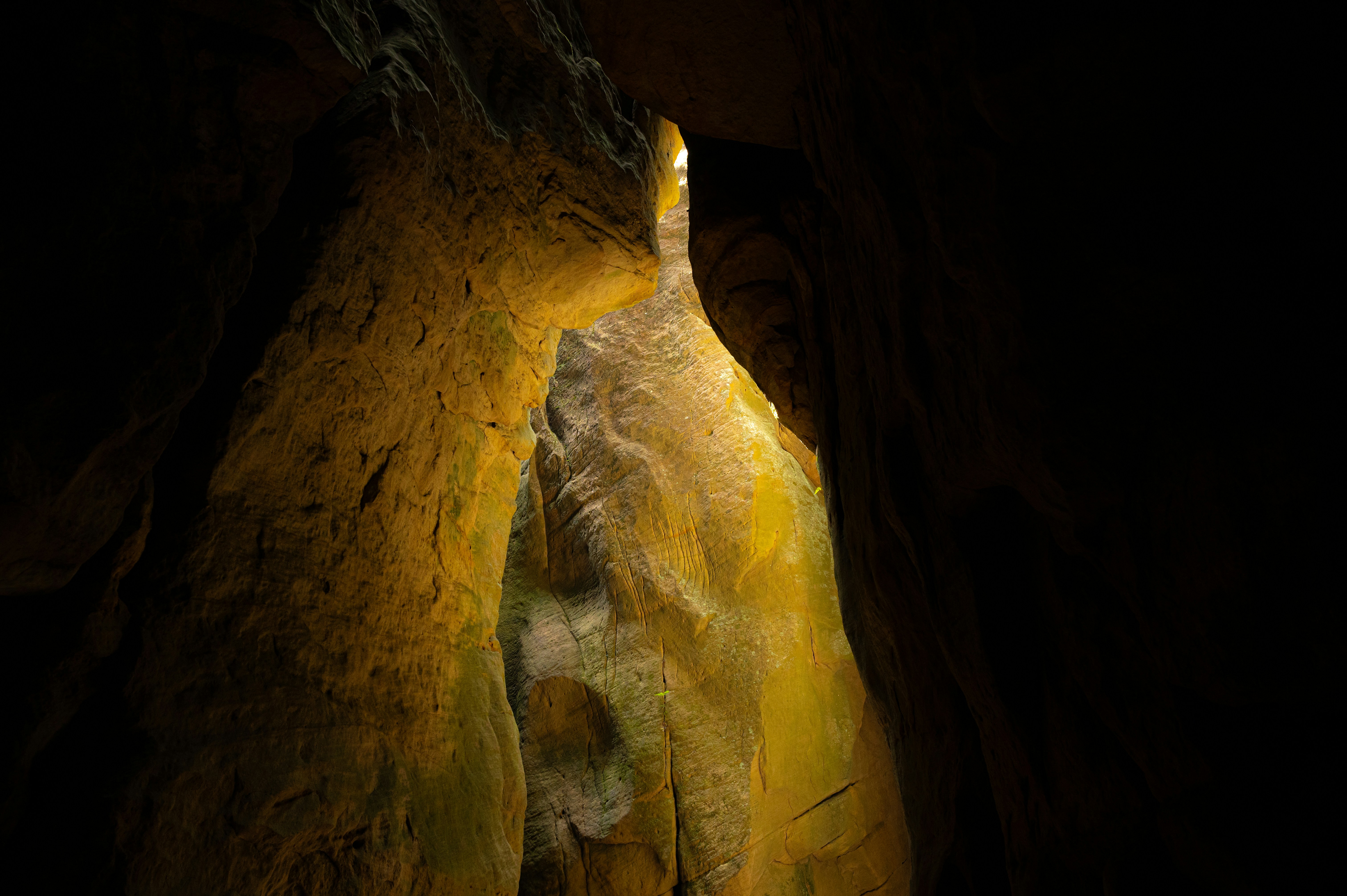 Golden glow in a narrow cave reveal