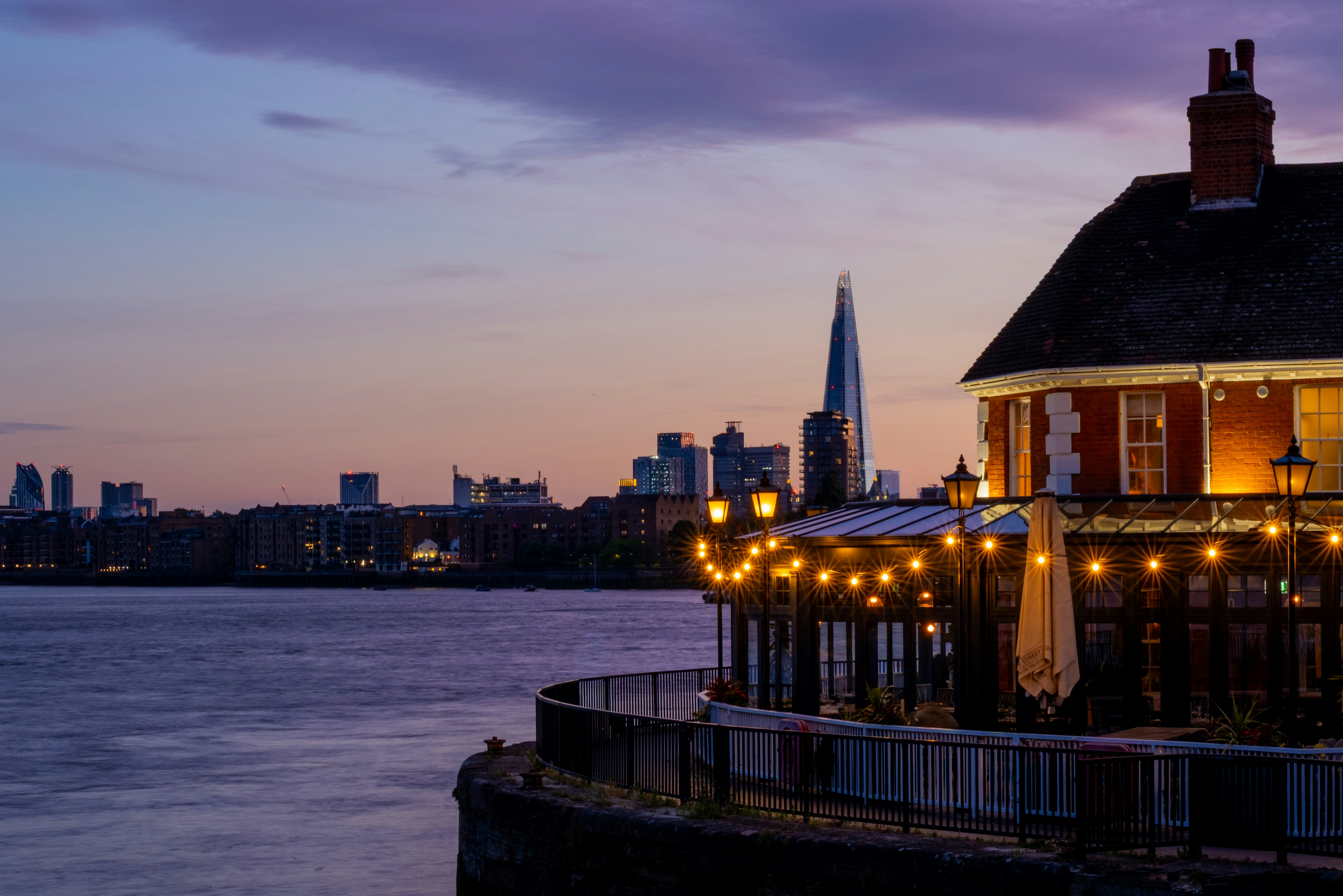 Harbor Bistro at Dusk: Warm Lights on the Riverside Terrace