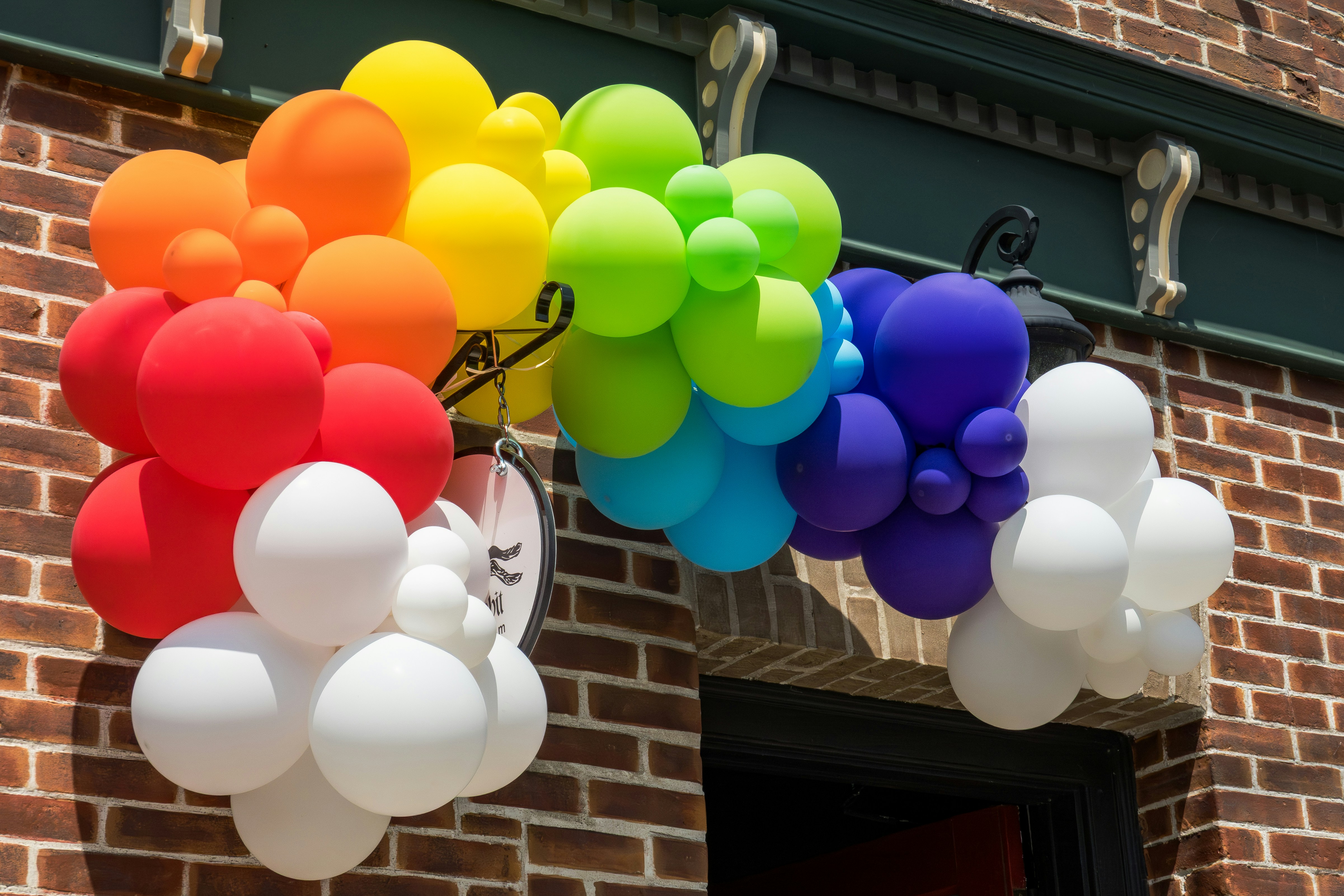 a store celebrating Pride Month with colorful balloons