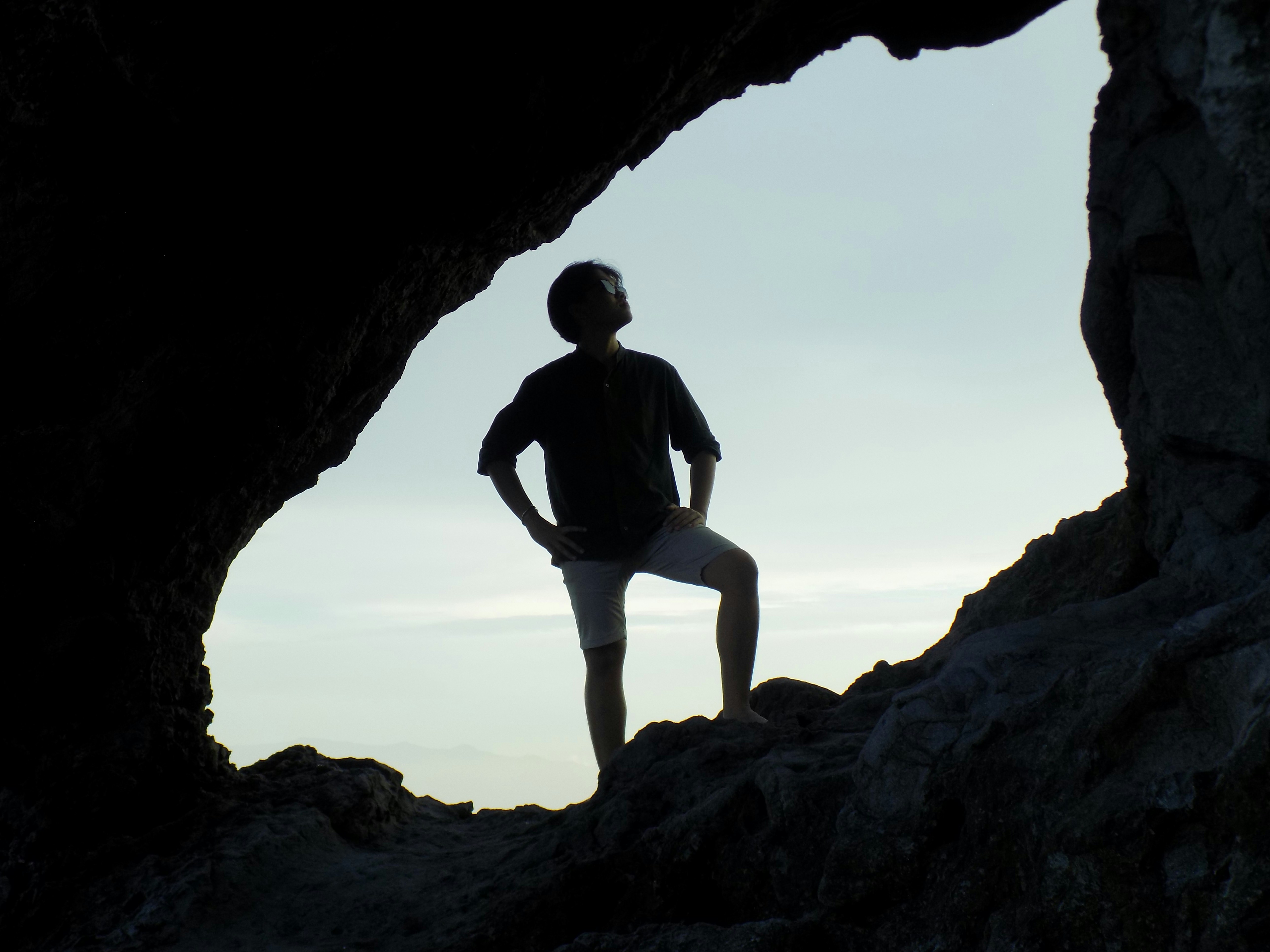 Silhouette at the Mouth of a Cliff: A Quiet Summit