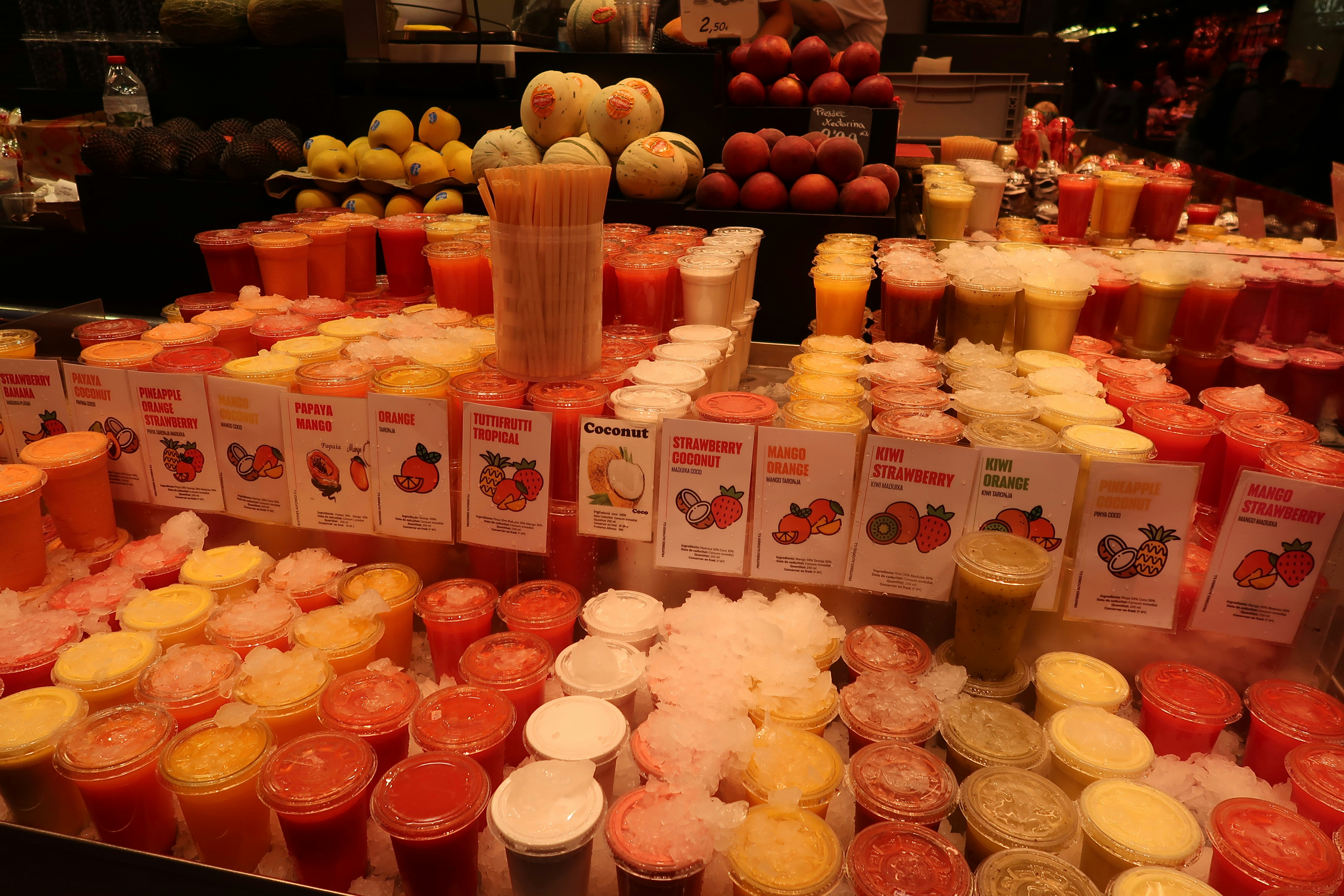 Juice Corner at the Market: Colorful Cups and Fresh Fruits on Display