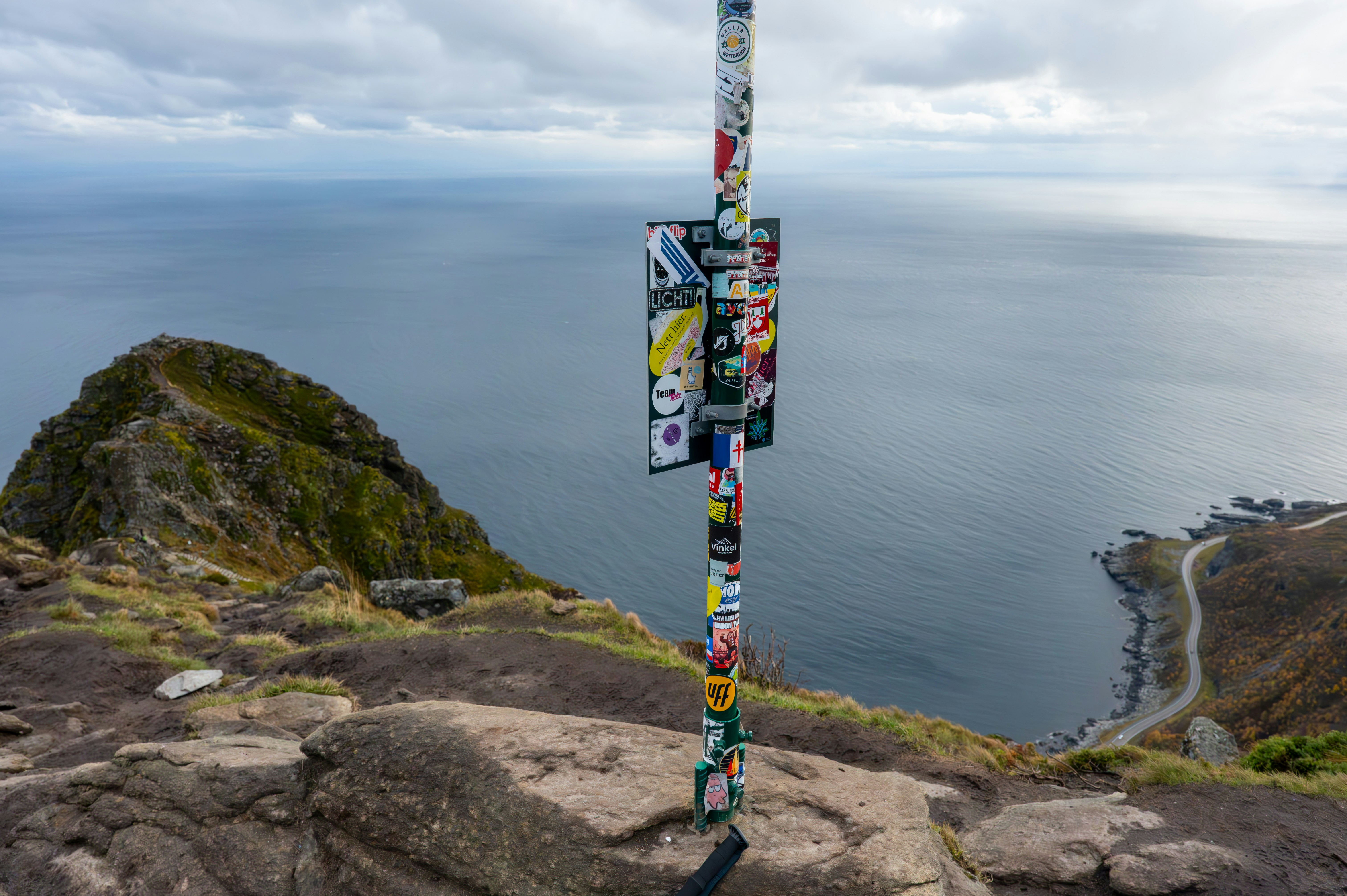Pole of Color: A Weathered Totem Reaching Toward the Atlantic Sky