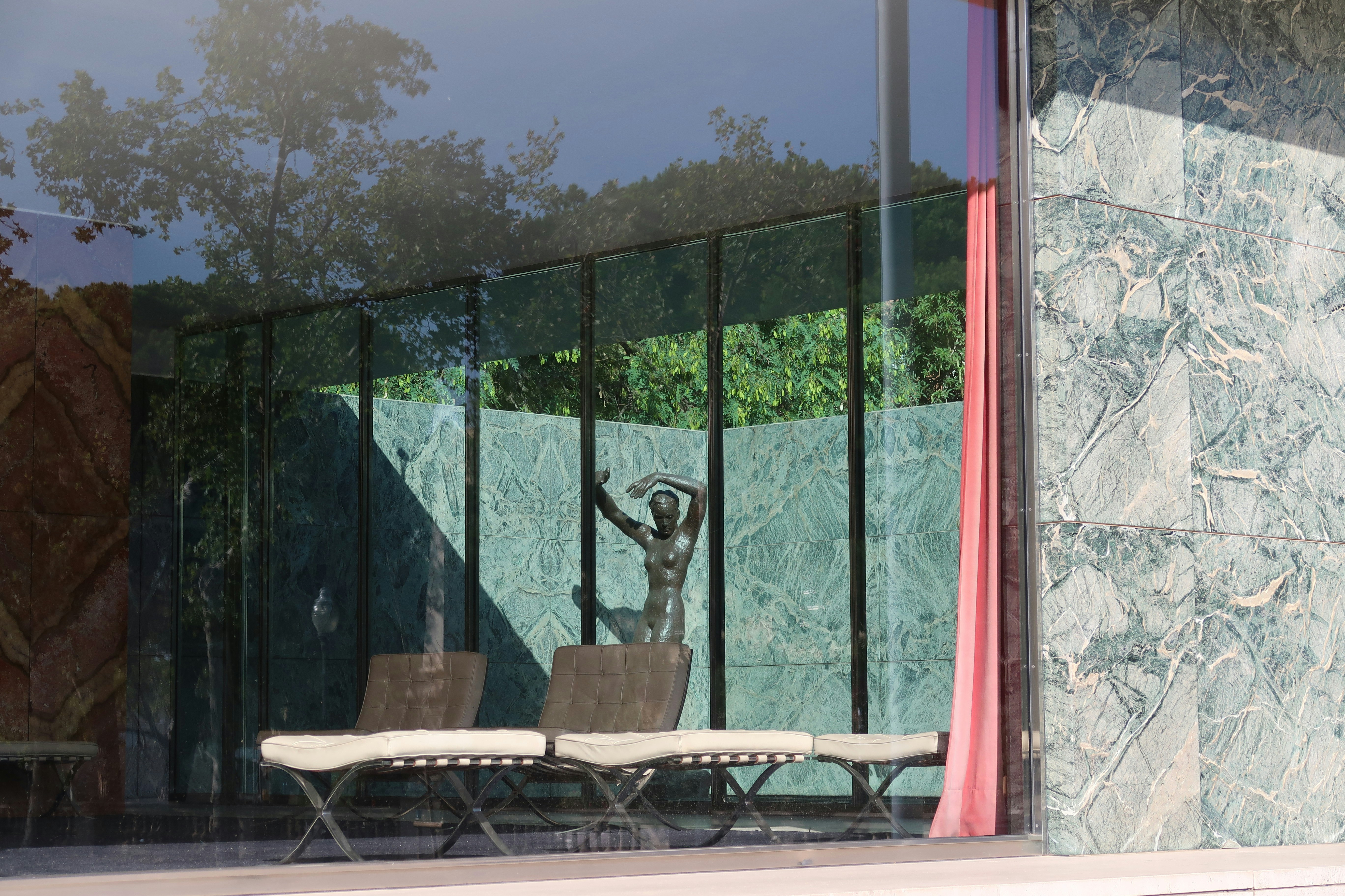 Reflection of a Relaxed Terrace Through Glass Panels