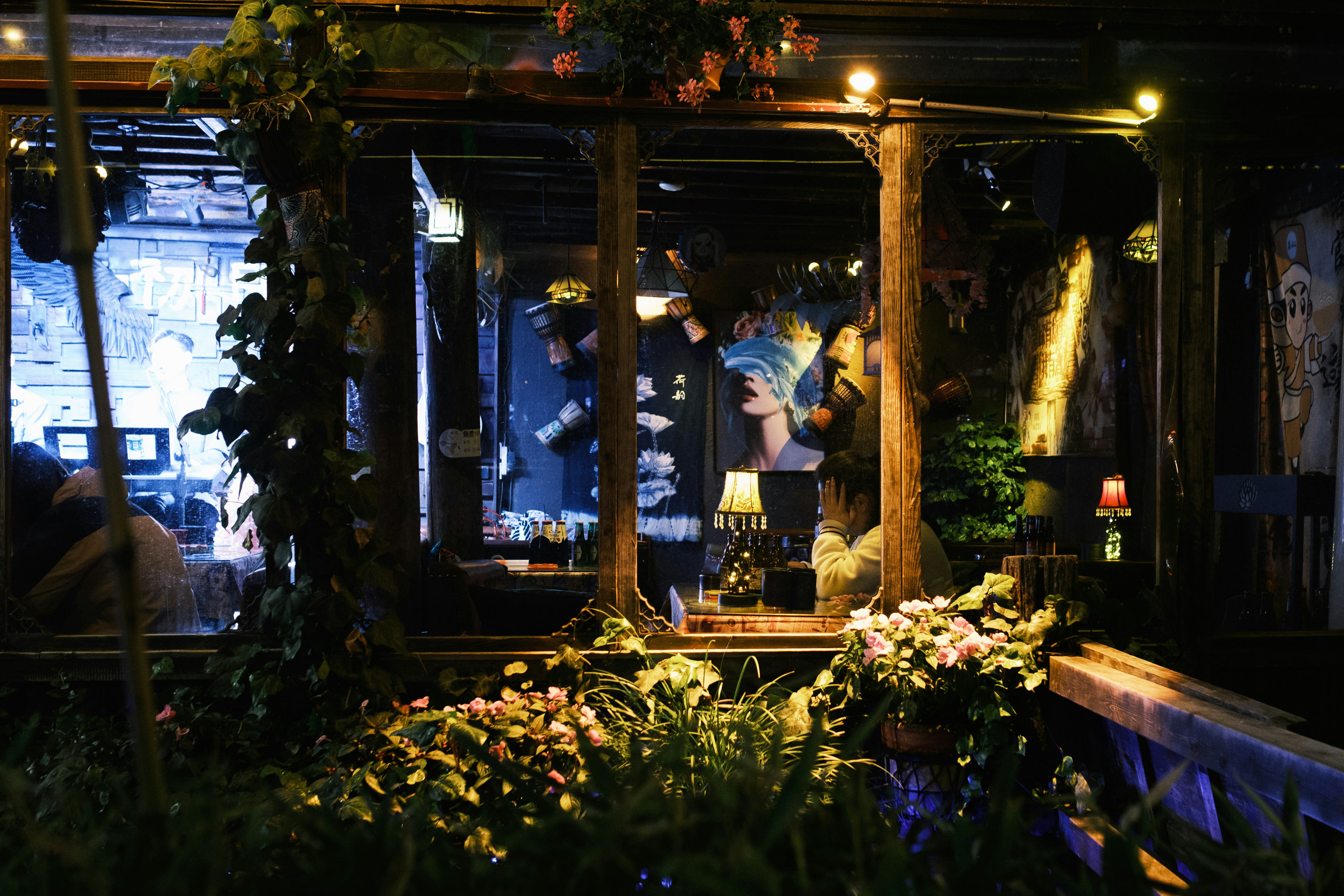 Night-lit Garden Behind Glass: A Cozy Bar Scene
