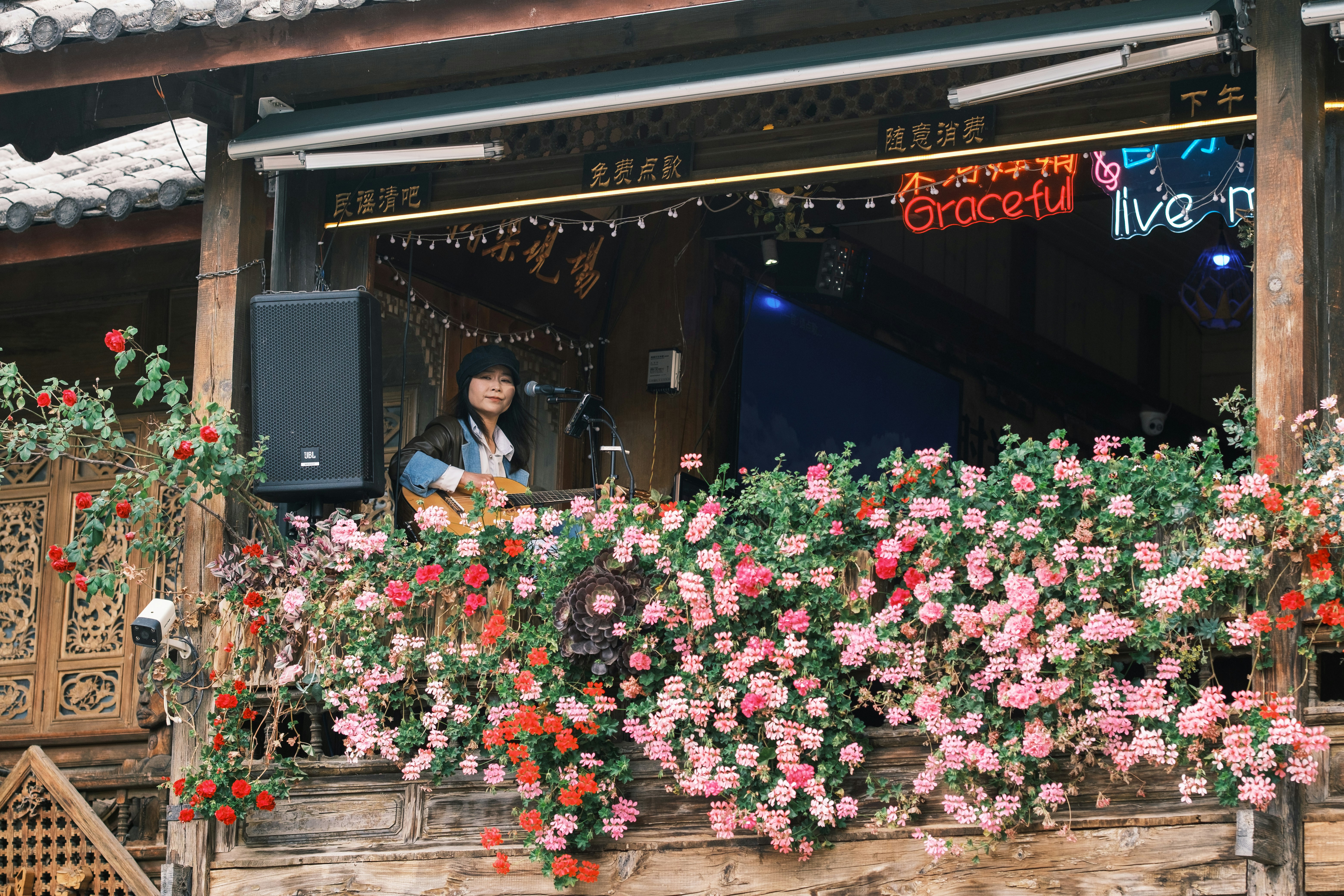 Florals and Fretwork: A Street Serenade from the Balcony