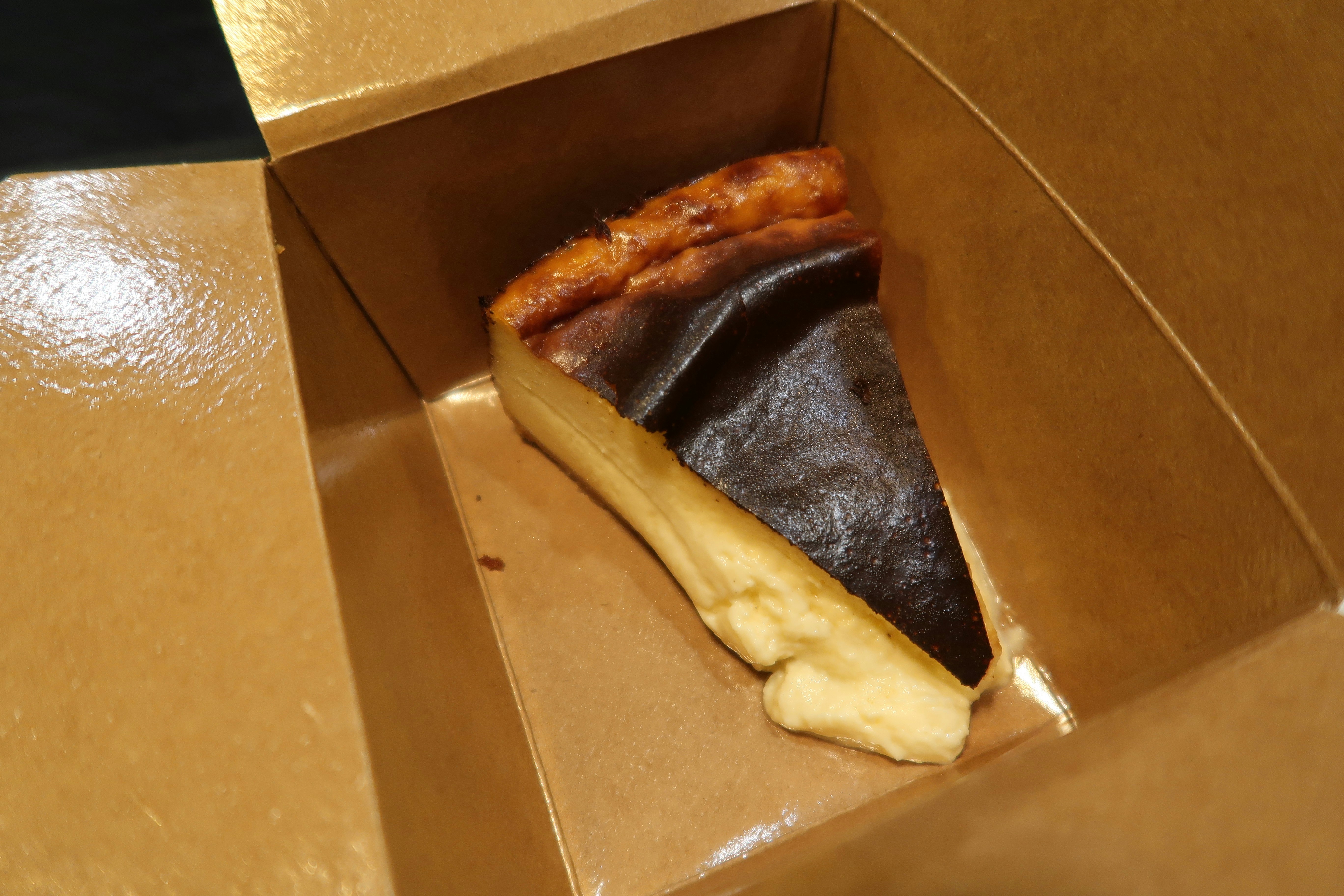 Lit Box, Dark Slice: A Glimpse of Pastry in Transit