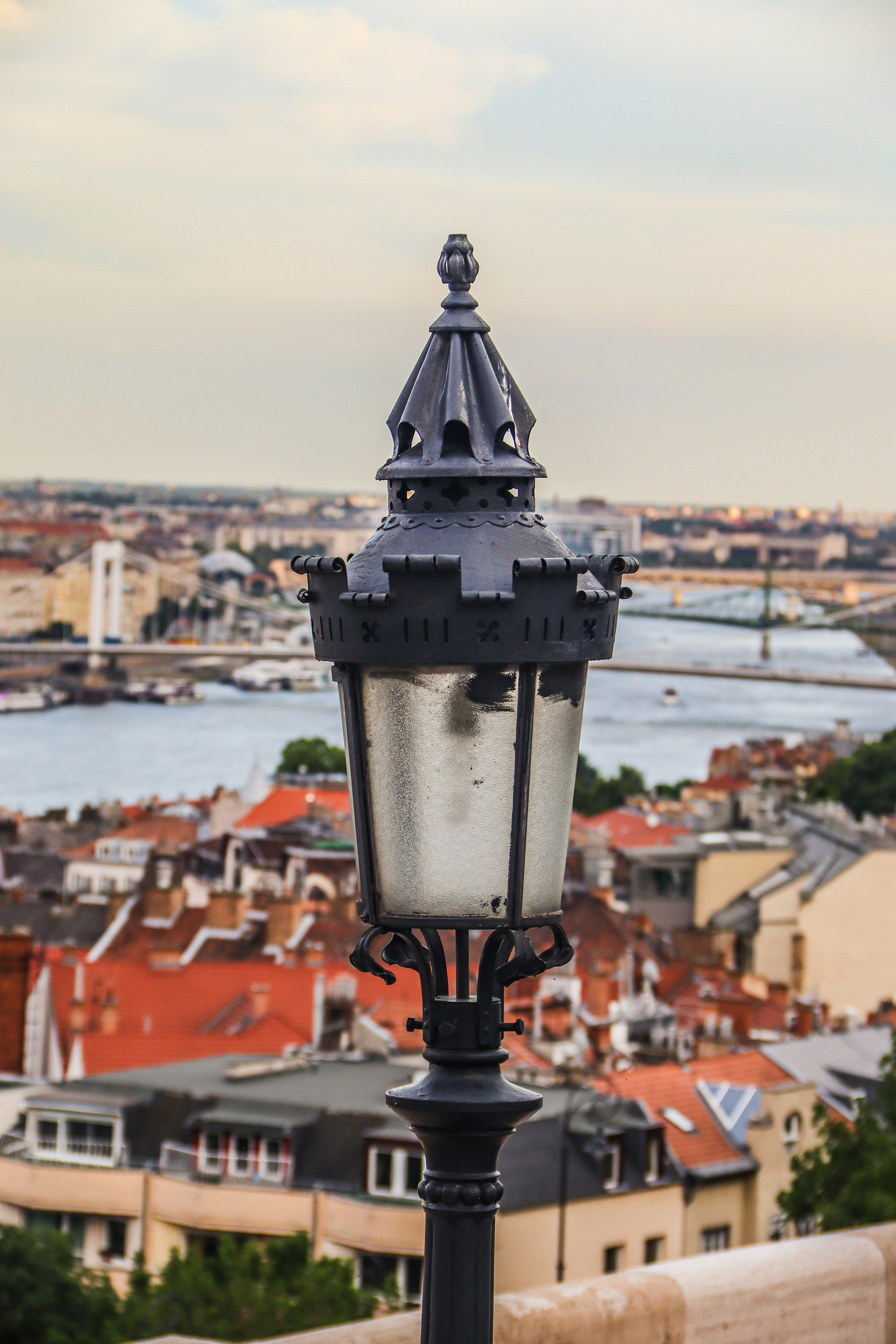 Gaslit Peak: A Vintage Lantern Overlooking a Rooftop City