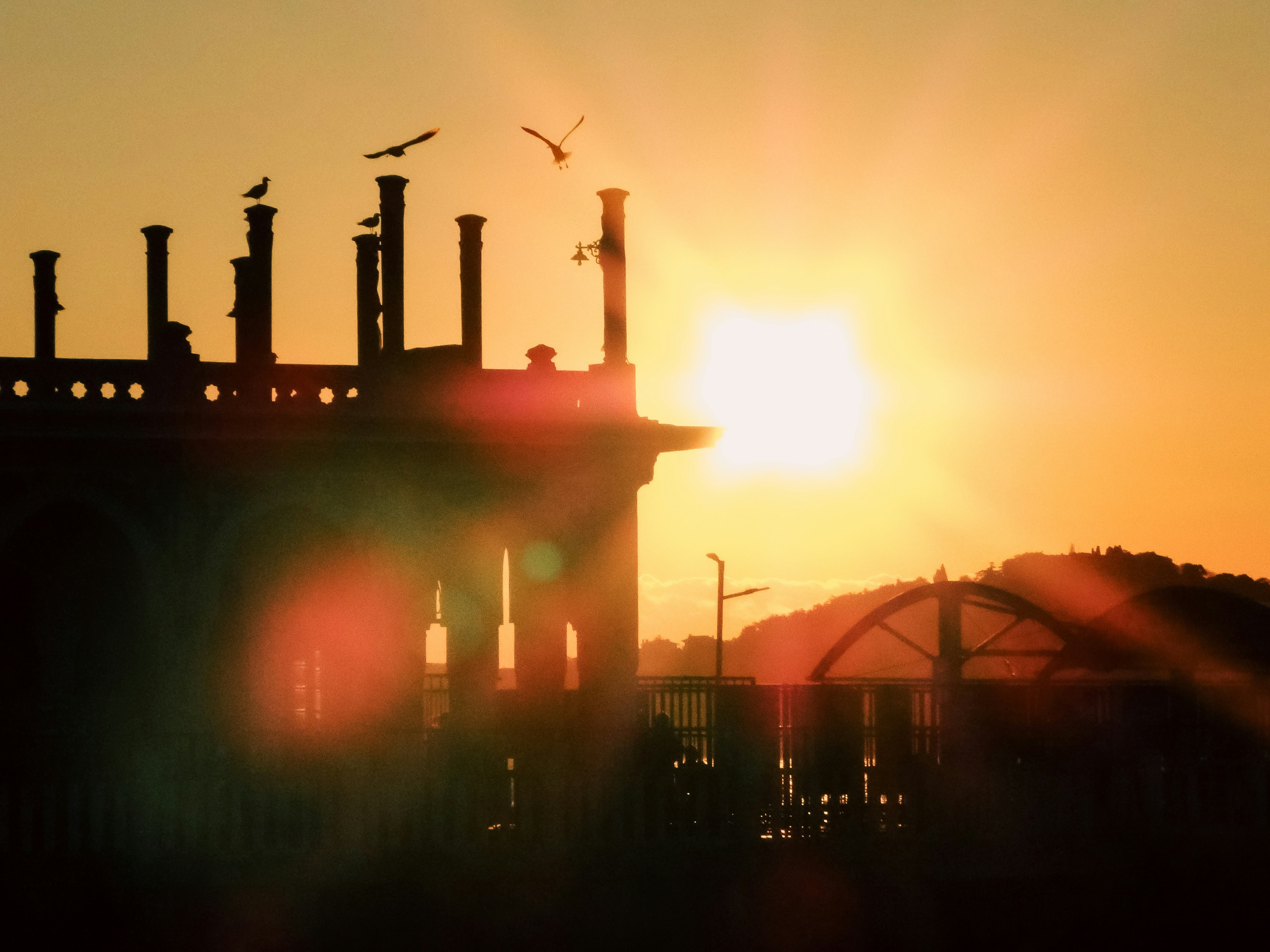 Sunlit Ruins: Silhouetted Columns Against a Brimming Horizon