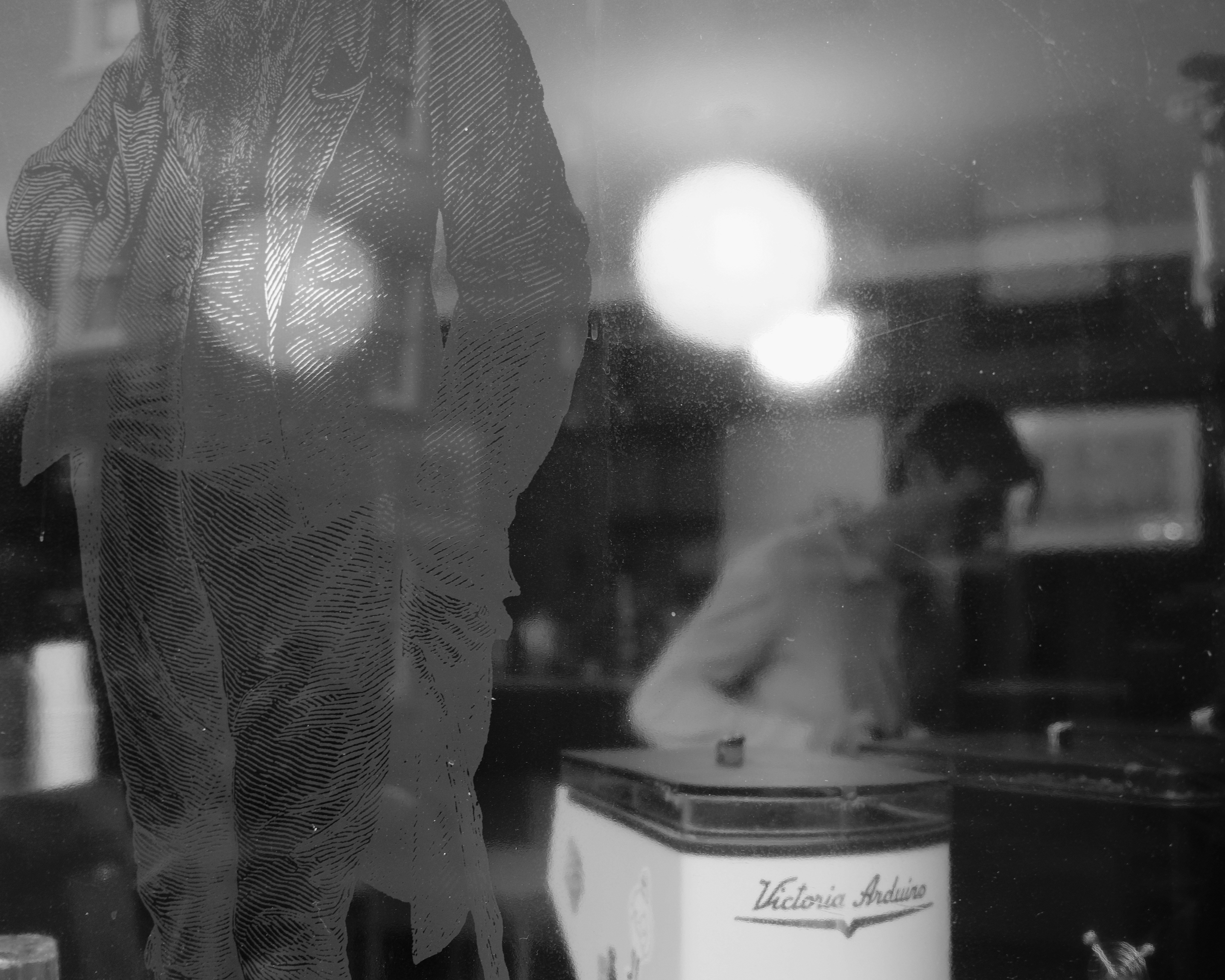 Ghostly Reflections: A Quiet Shop Window in Monochrome