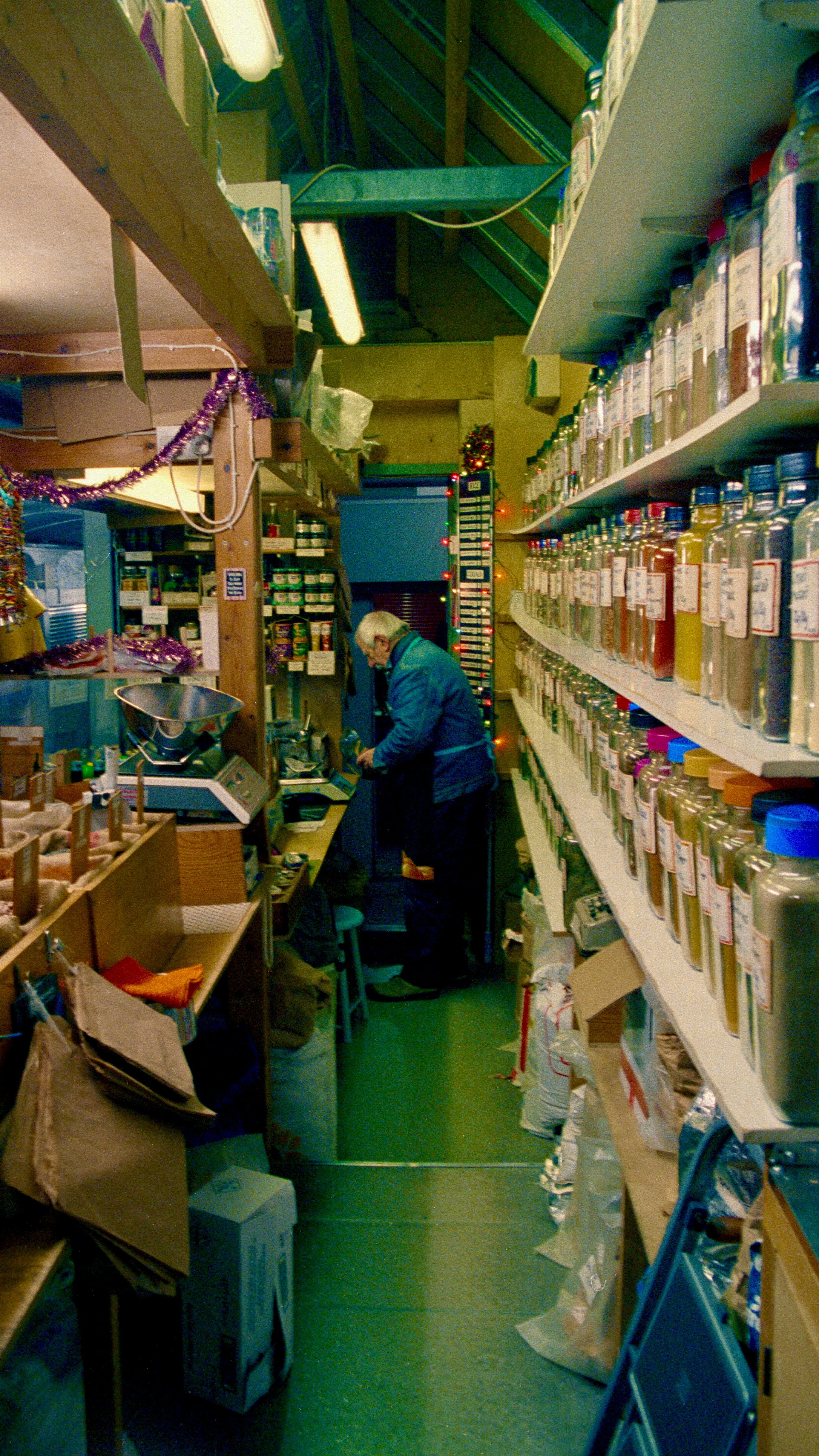 A Lone Clerk in a Narrow Workshop Aisle