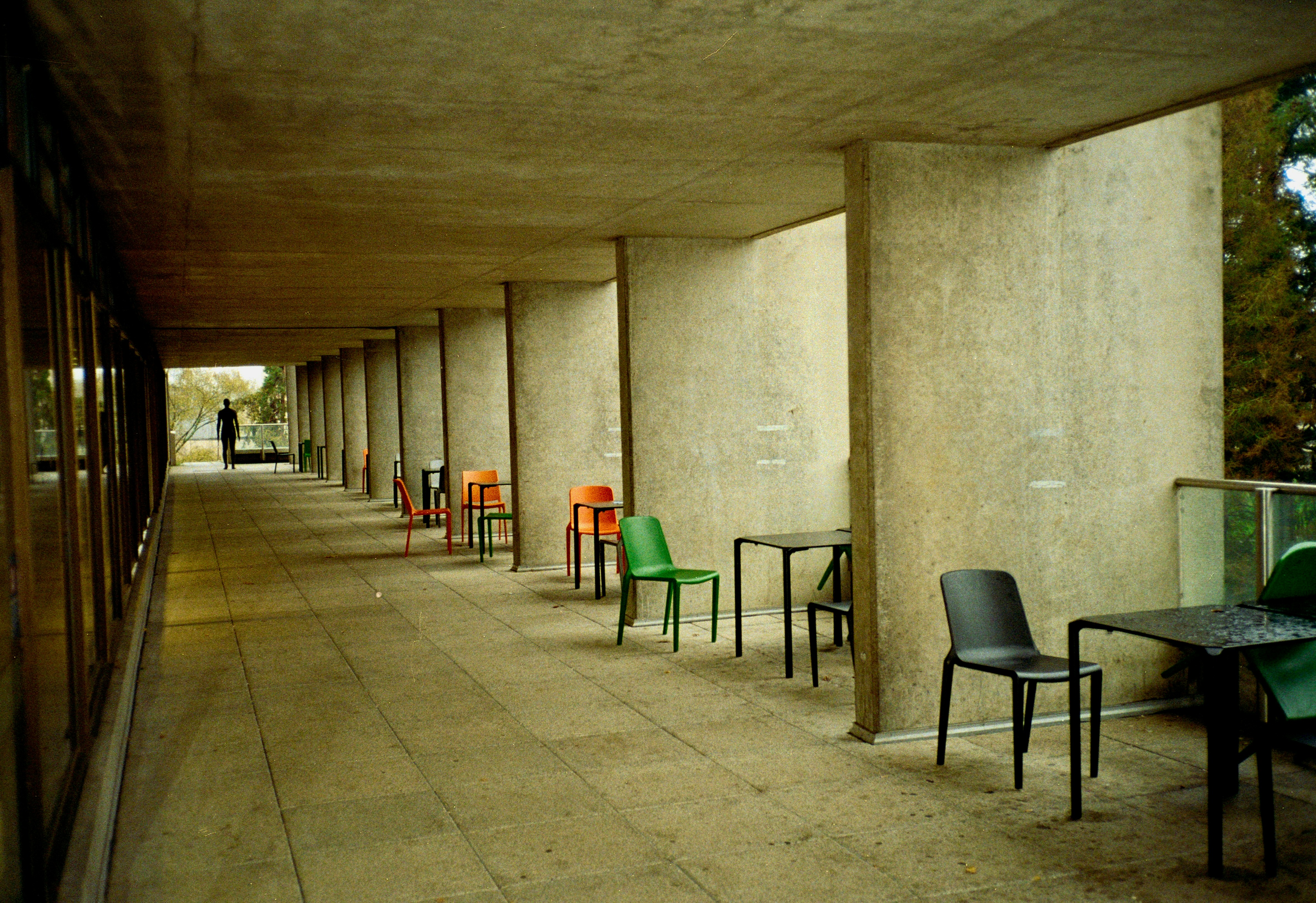 Lonely Corridor: Rows of Chairs Leading to a Distant Figure