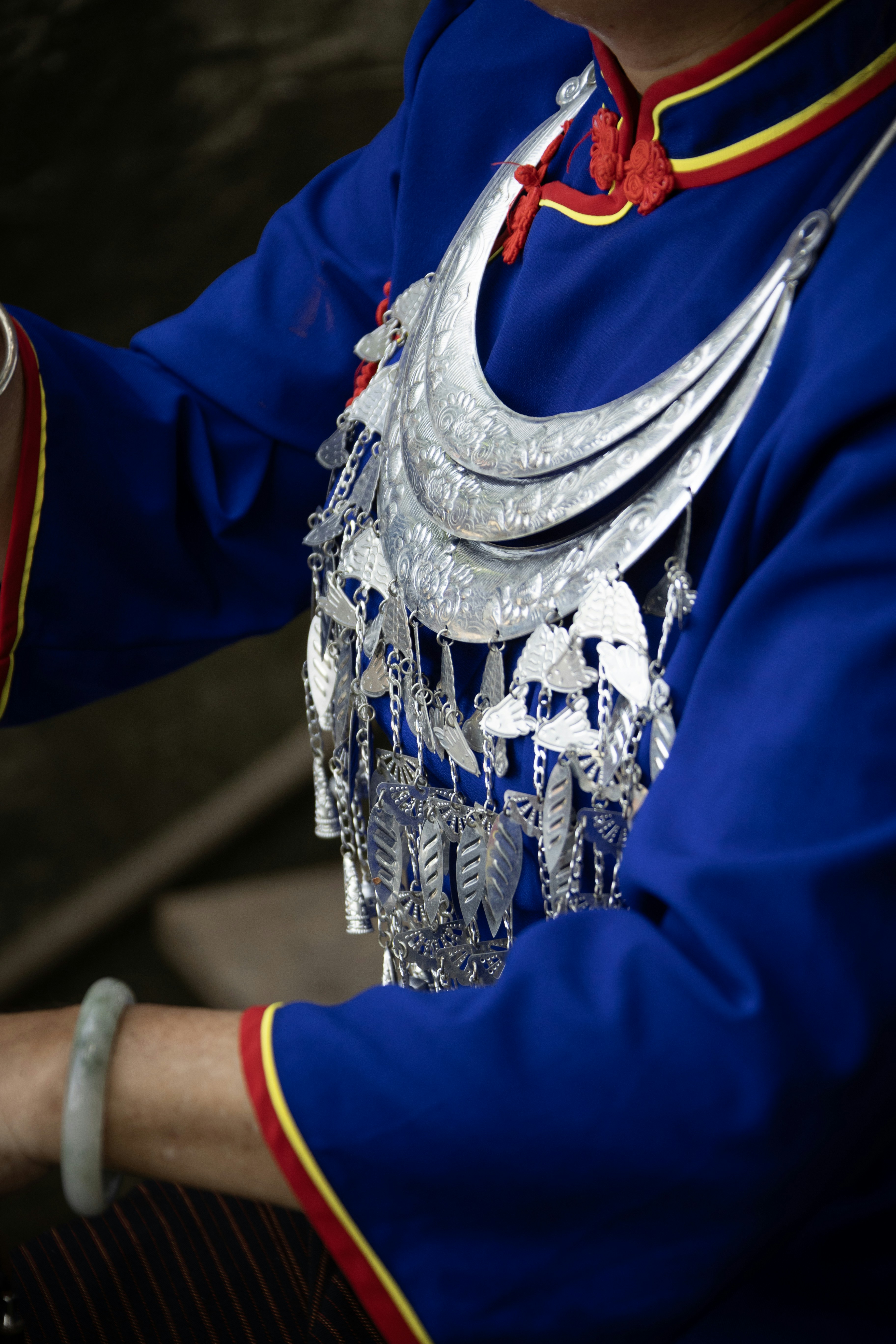 Silver Ornate Ornaments Adorning a Royal Blue Garment