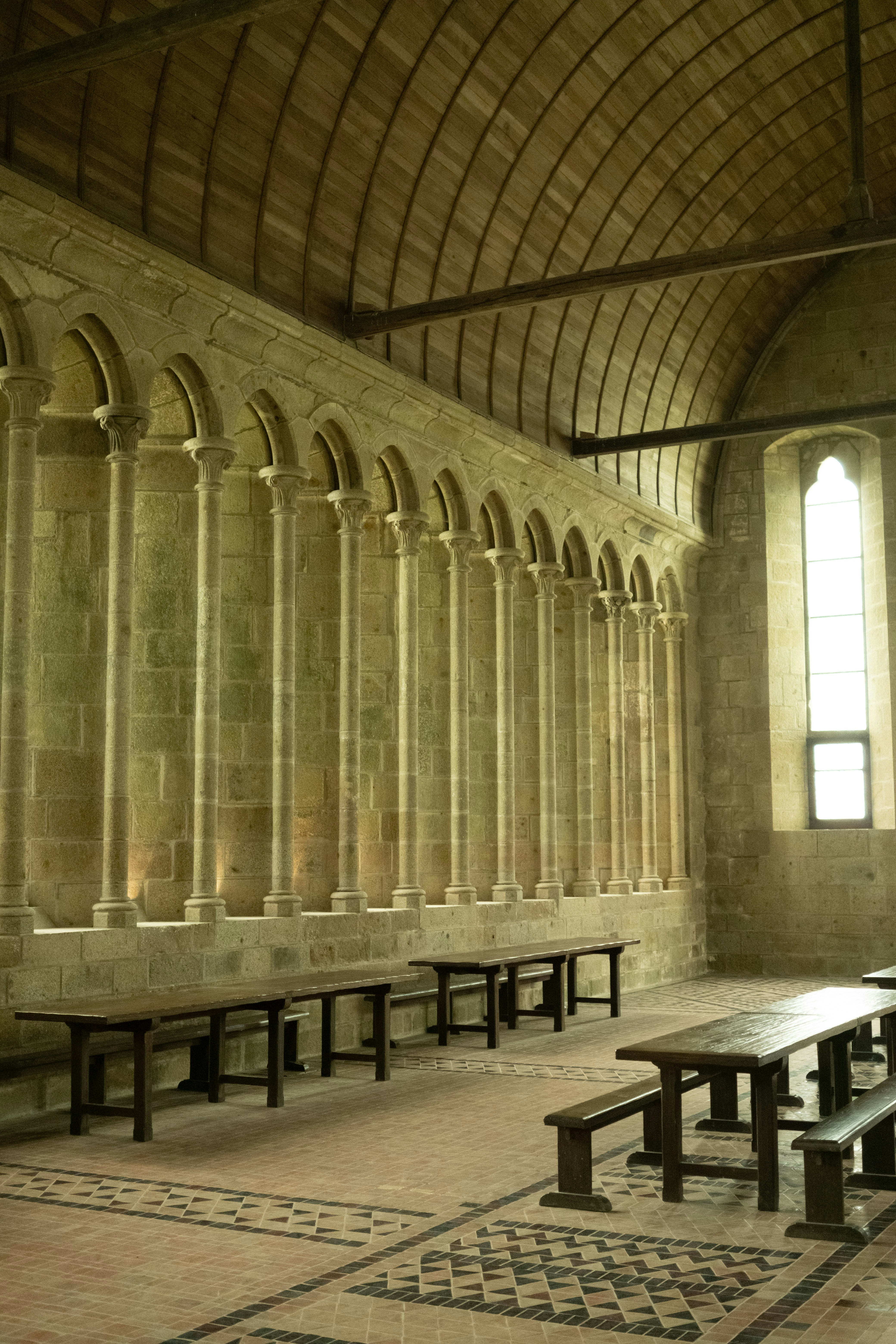 Echoes of Stone: A Quiet Nave with Arched Columns and Sunlit Window