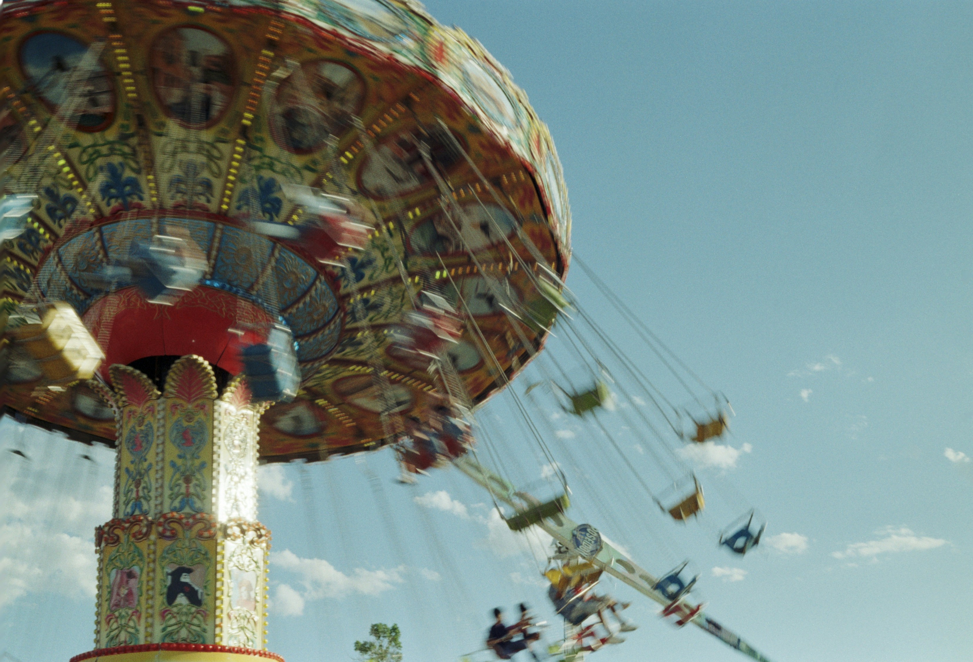 Whirl of Color: Carousel in a Bright Afternoon