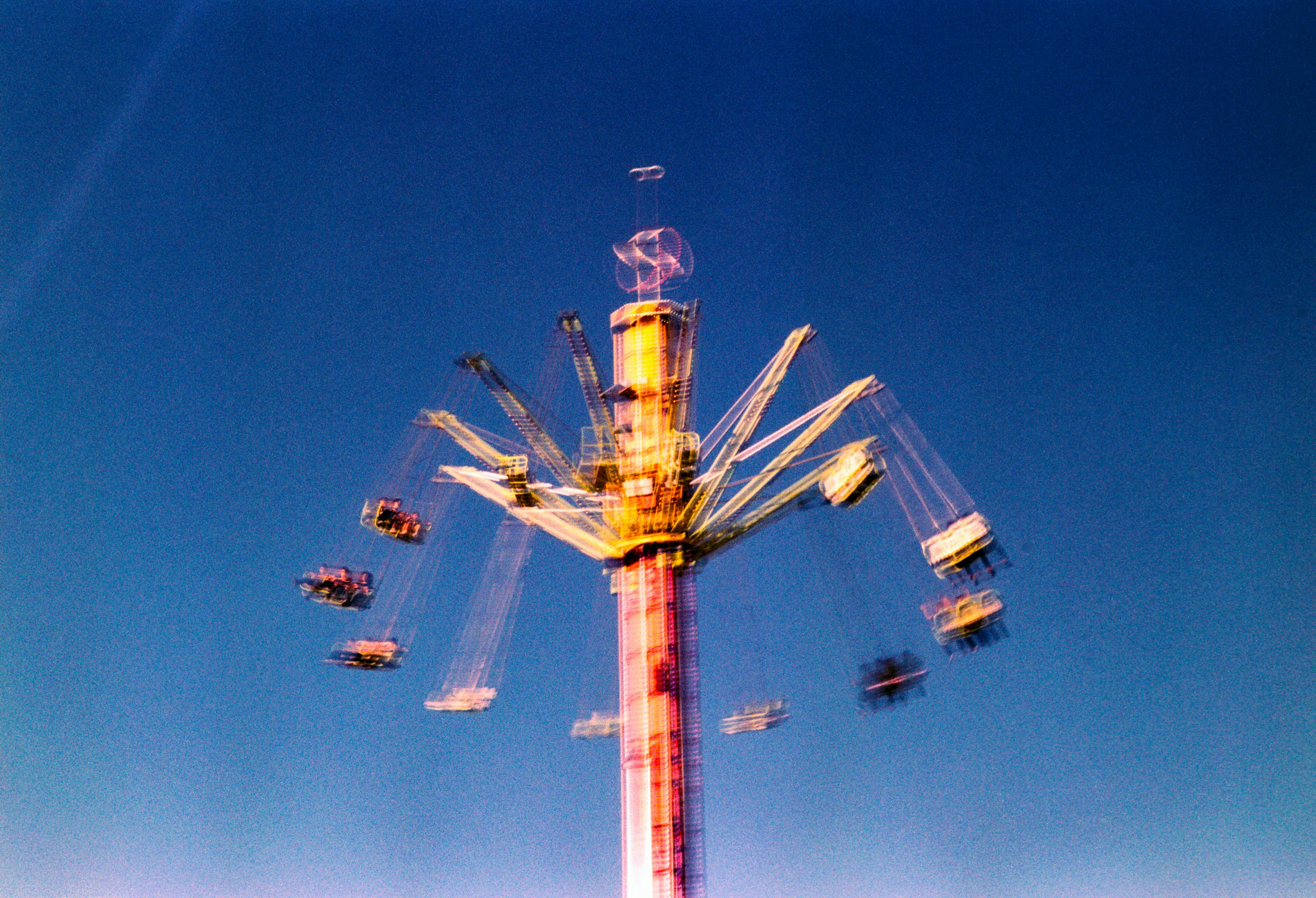 Spin of Light: A Carousel Swing in a Clear Summer Sky