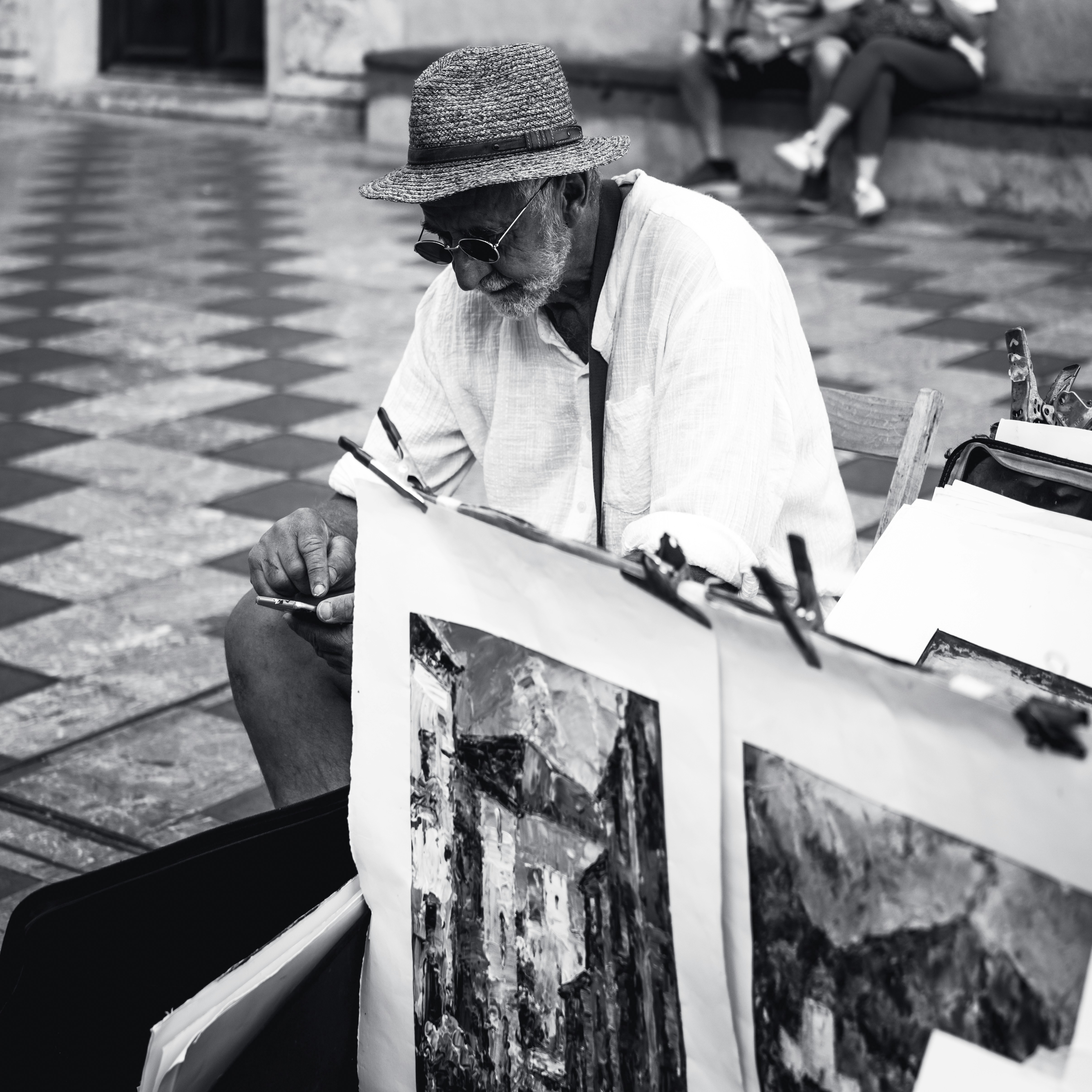 The Street Painter in the Courtyard: A Quiet Moment with Ink and Light