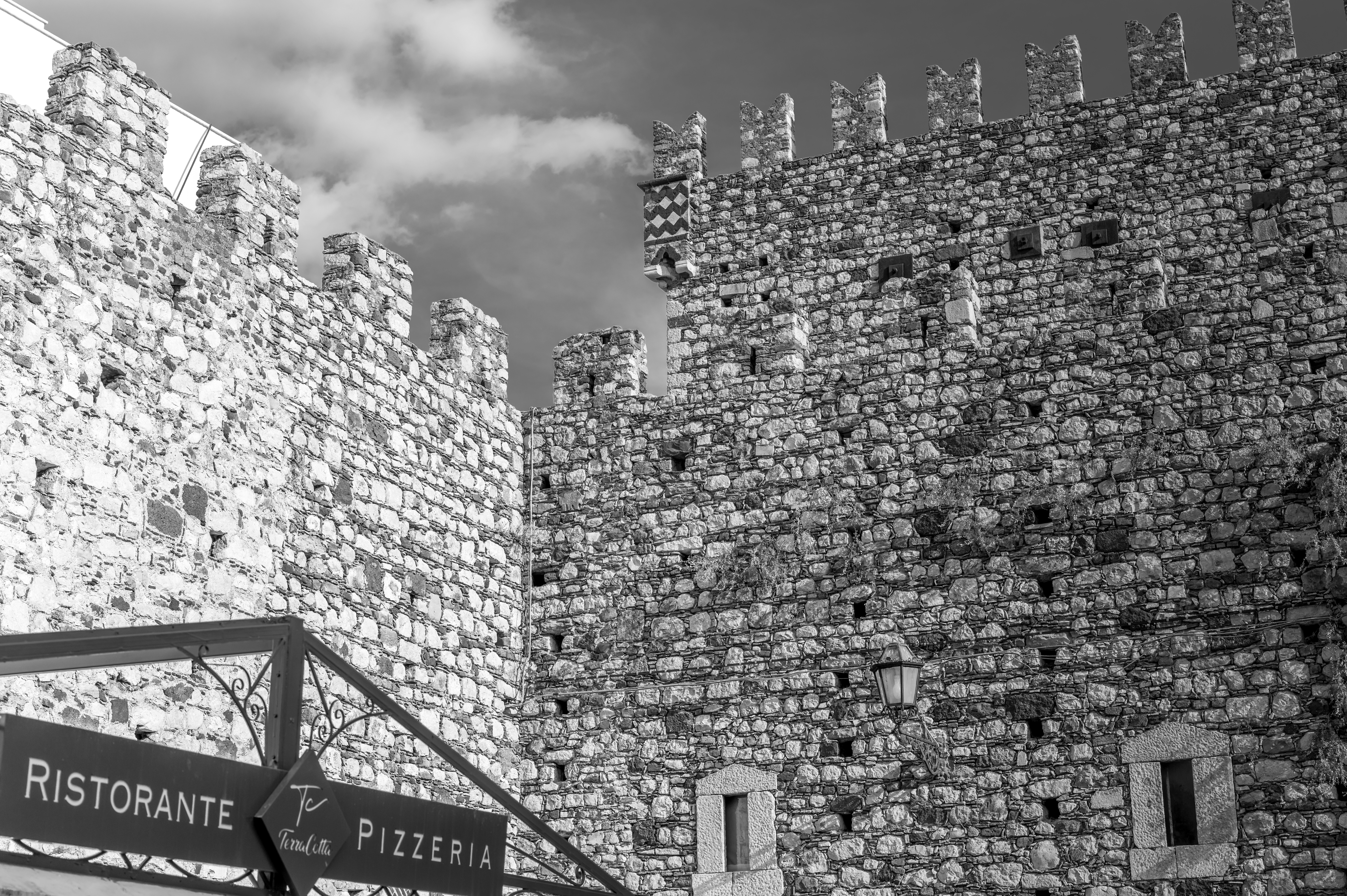 Castle Facade and Ristorante Signage Under Carved Sky