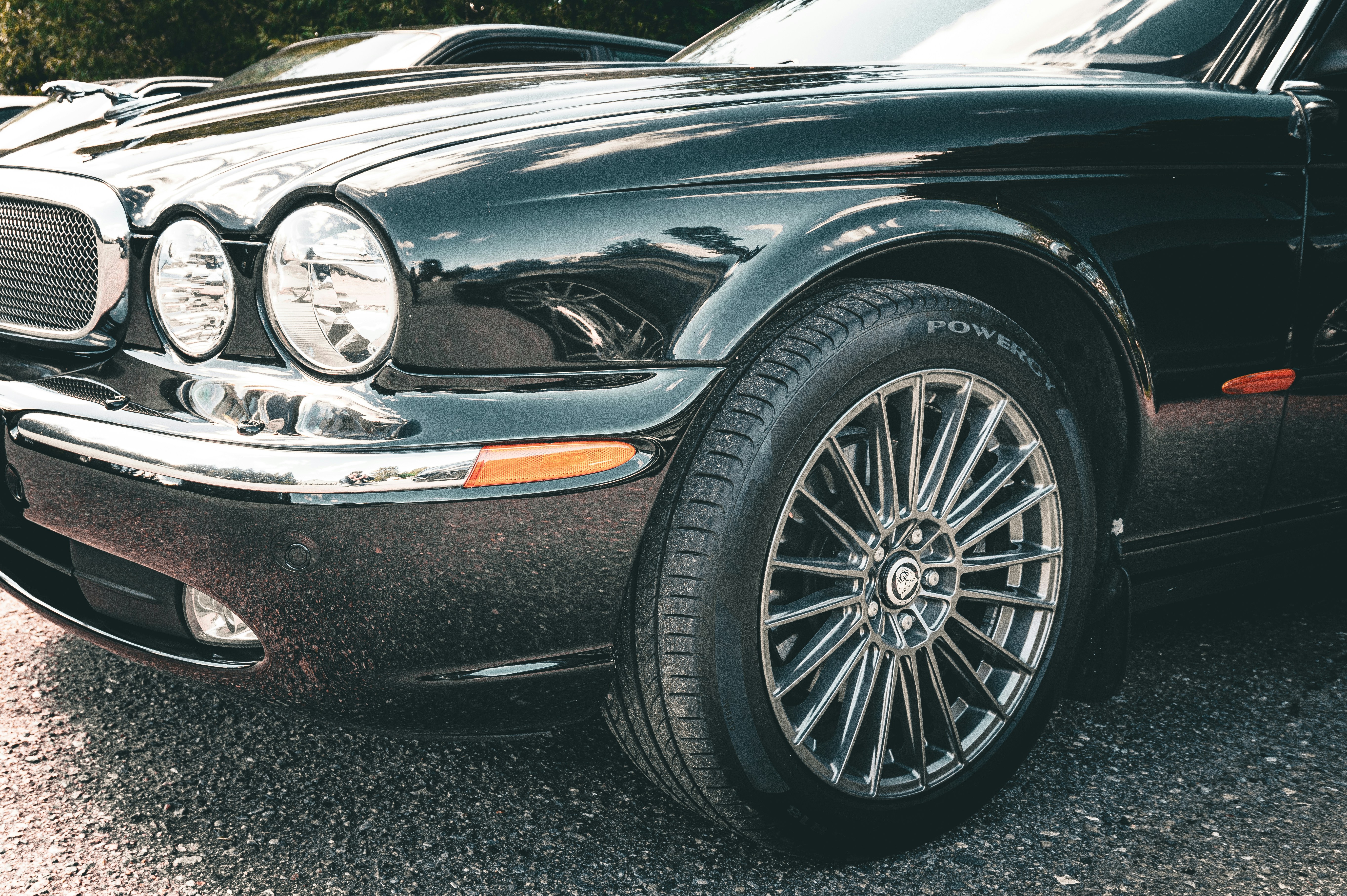 Shiny hood and multi-spoked wheel: a classic car up close