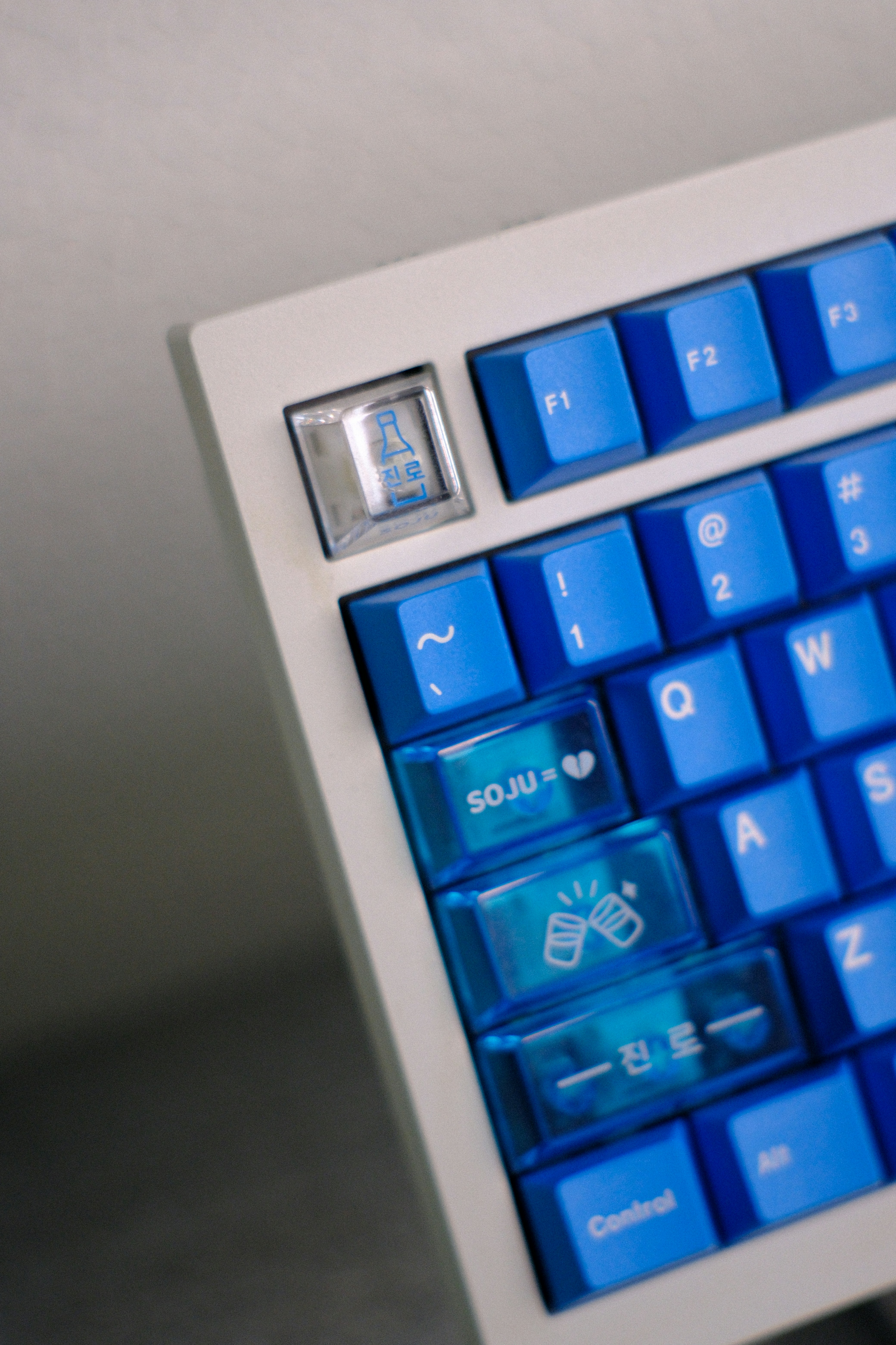 Mechanical keyboard with blue soju-themed custom keycaps.