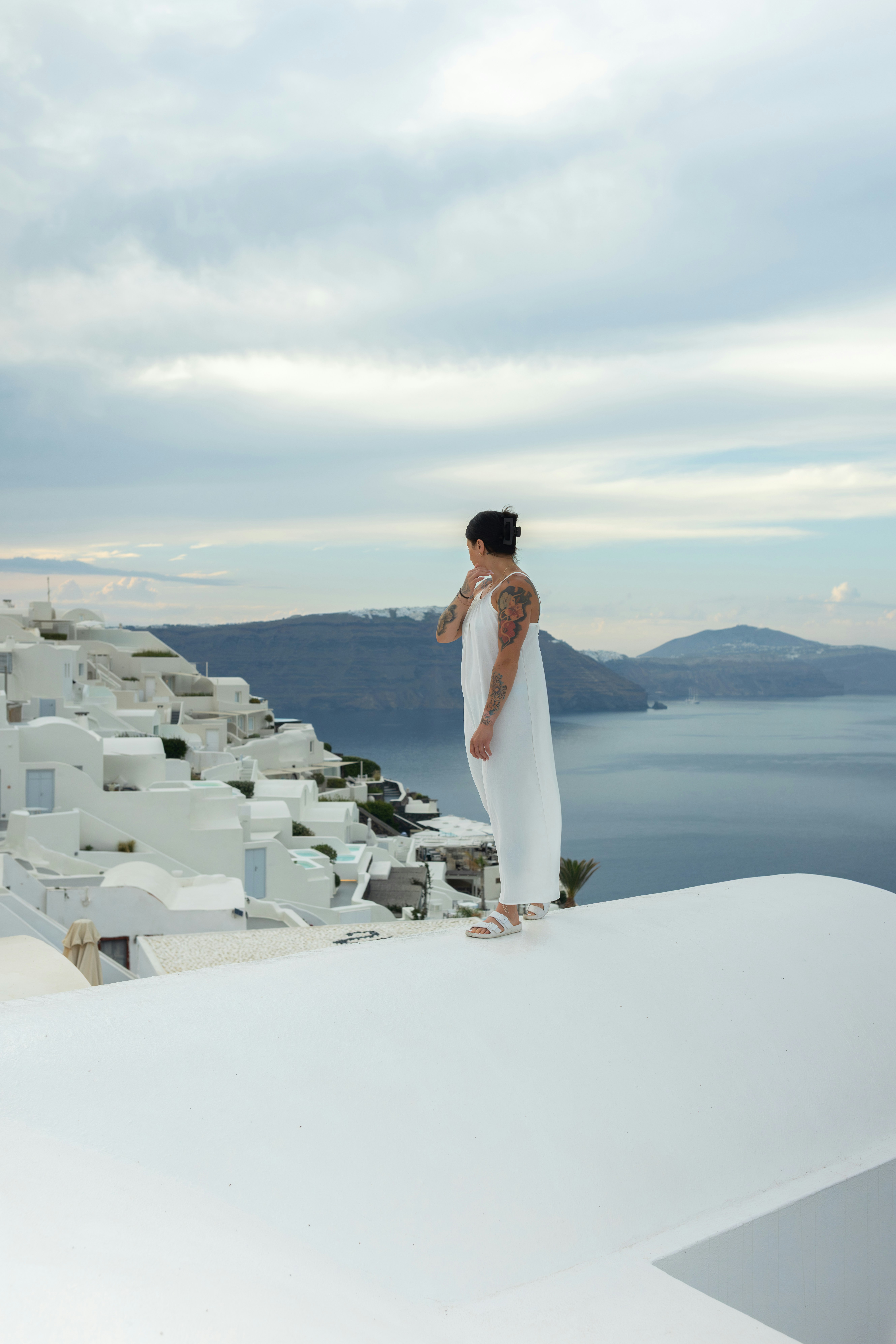 Solitary silhouette on Santorini white-washed ledge