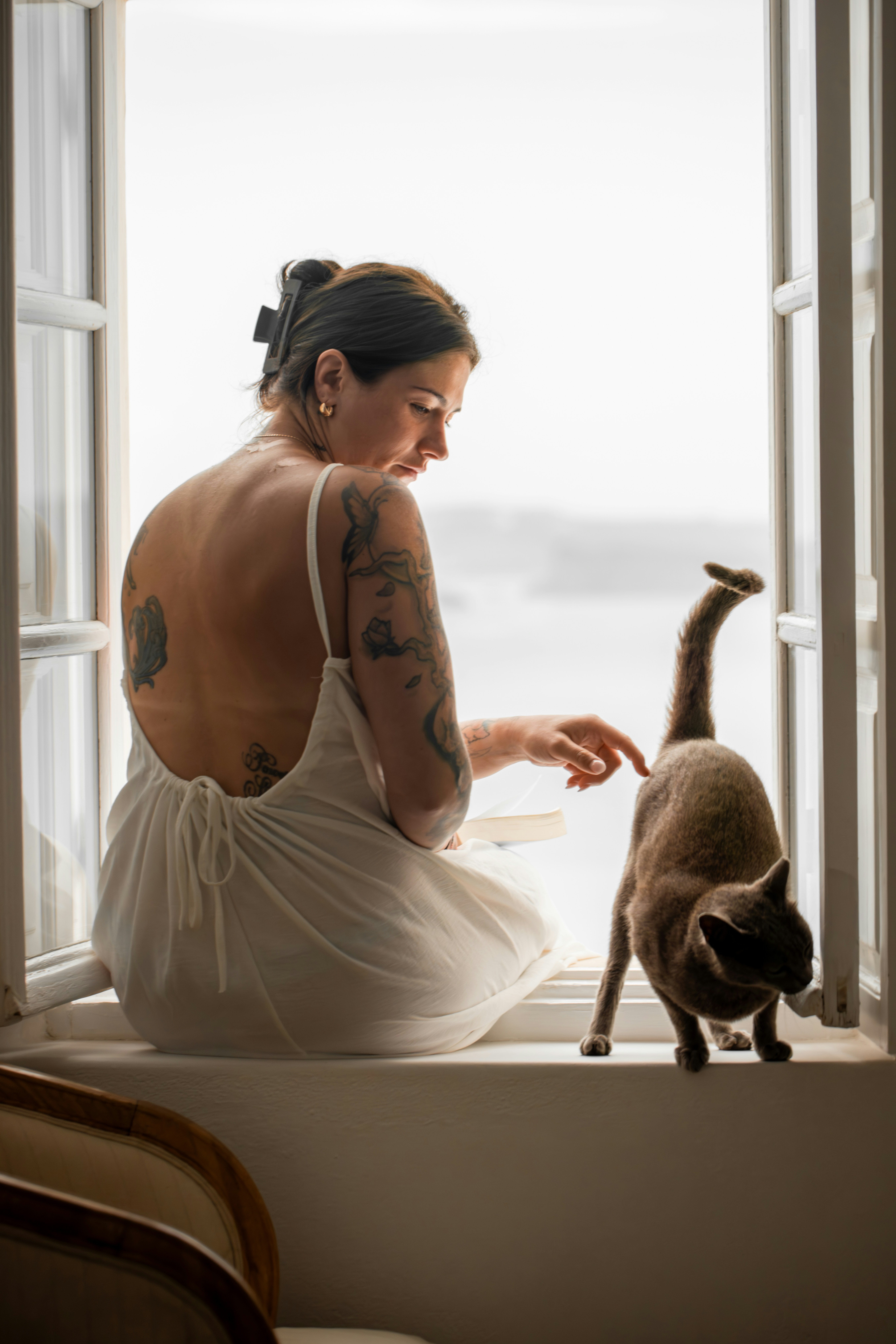 Quiet Moment at the Windowsill: Tattooed Woman with Cat