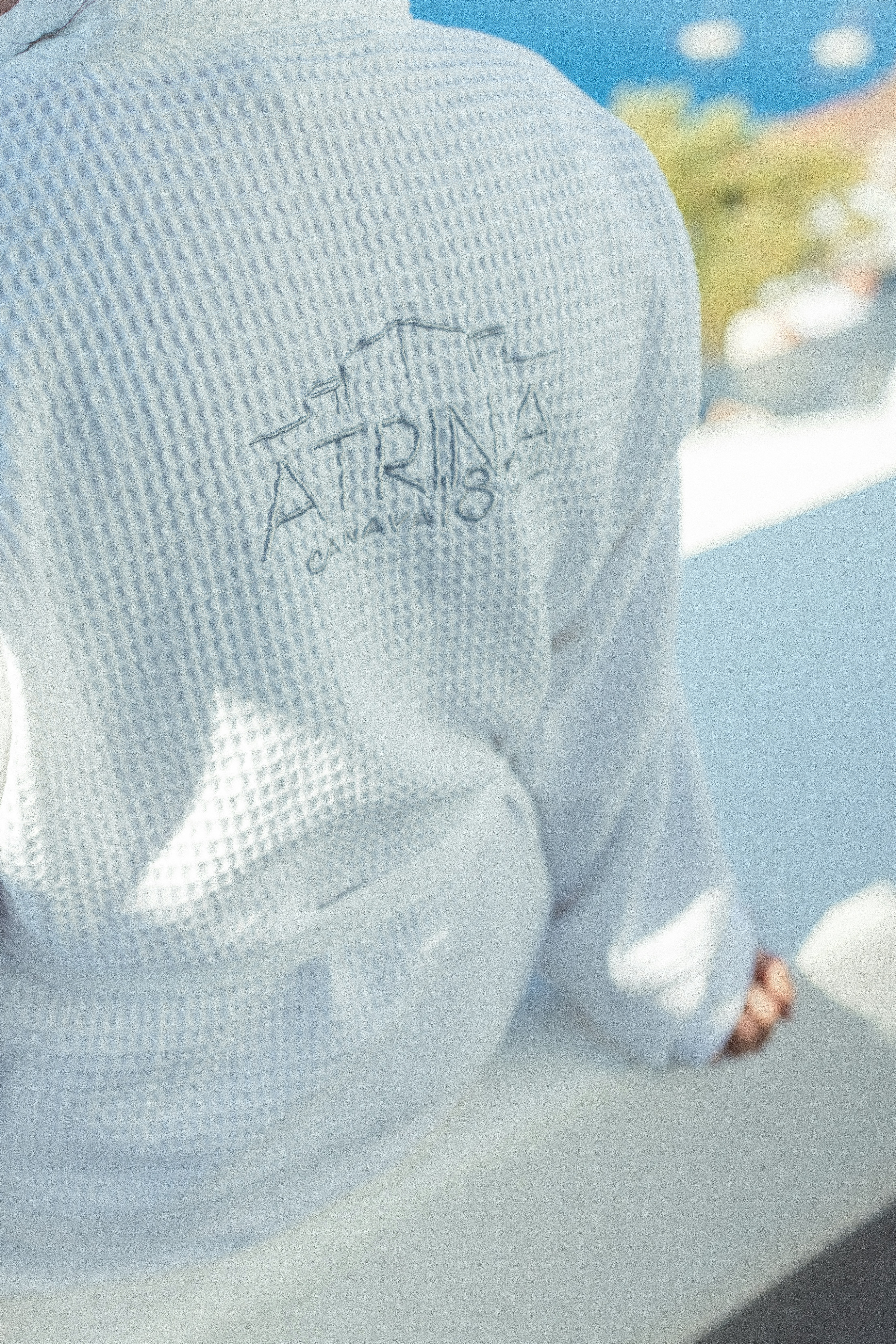 Embroidered Alpine Logo on Textured White Fabric