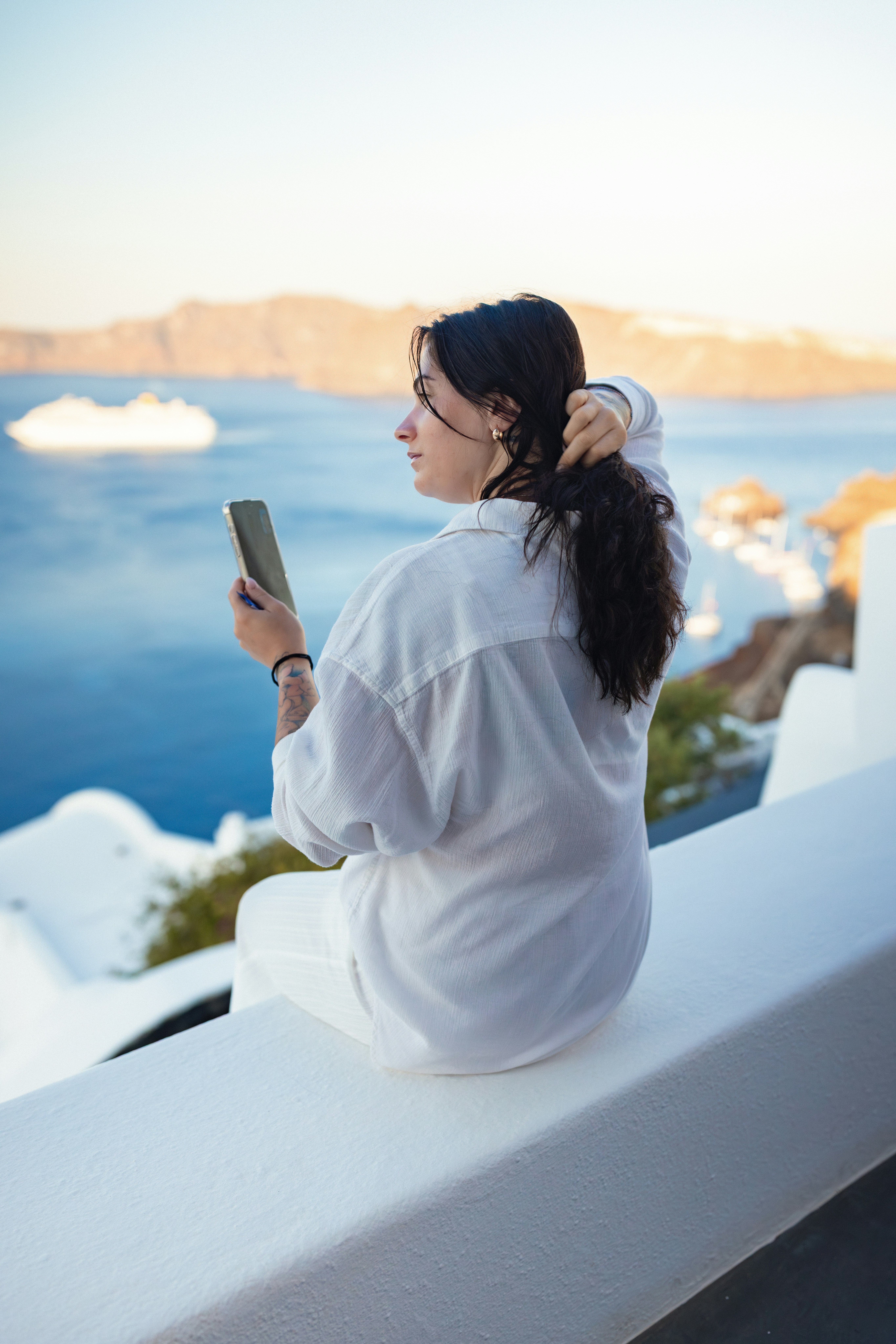 Seaside Portrait: Quiet Moment with a Phone by the Sea