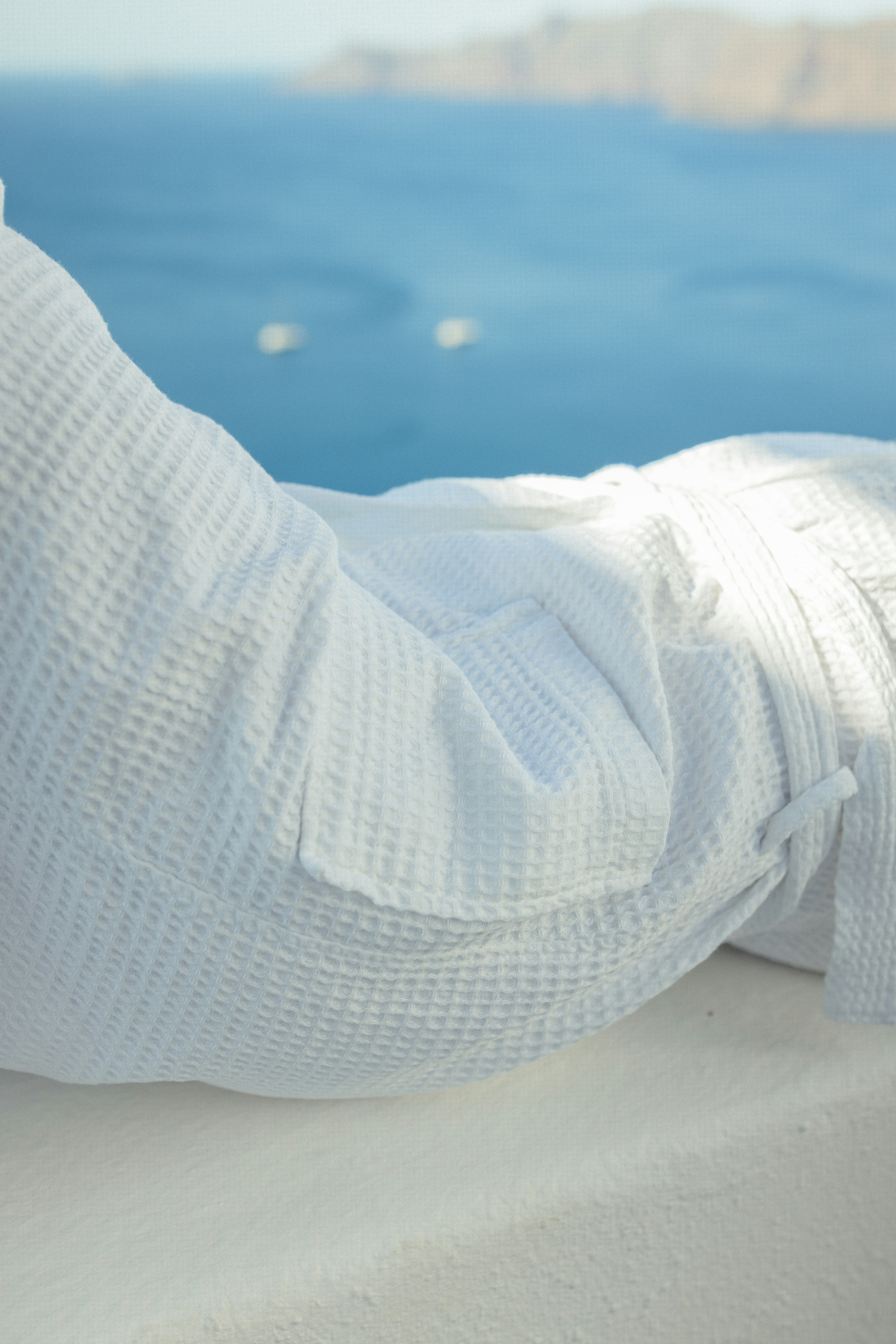 White knit sleeve against sea horizon