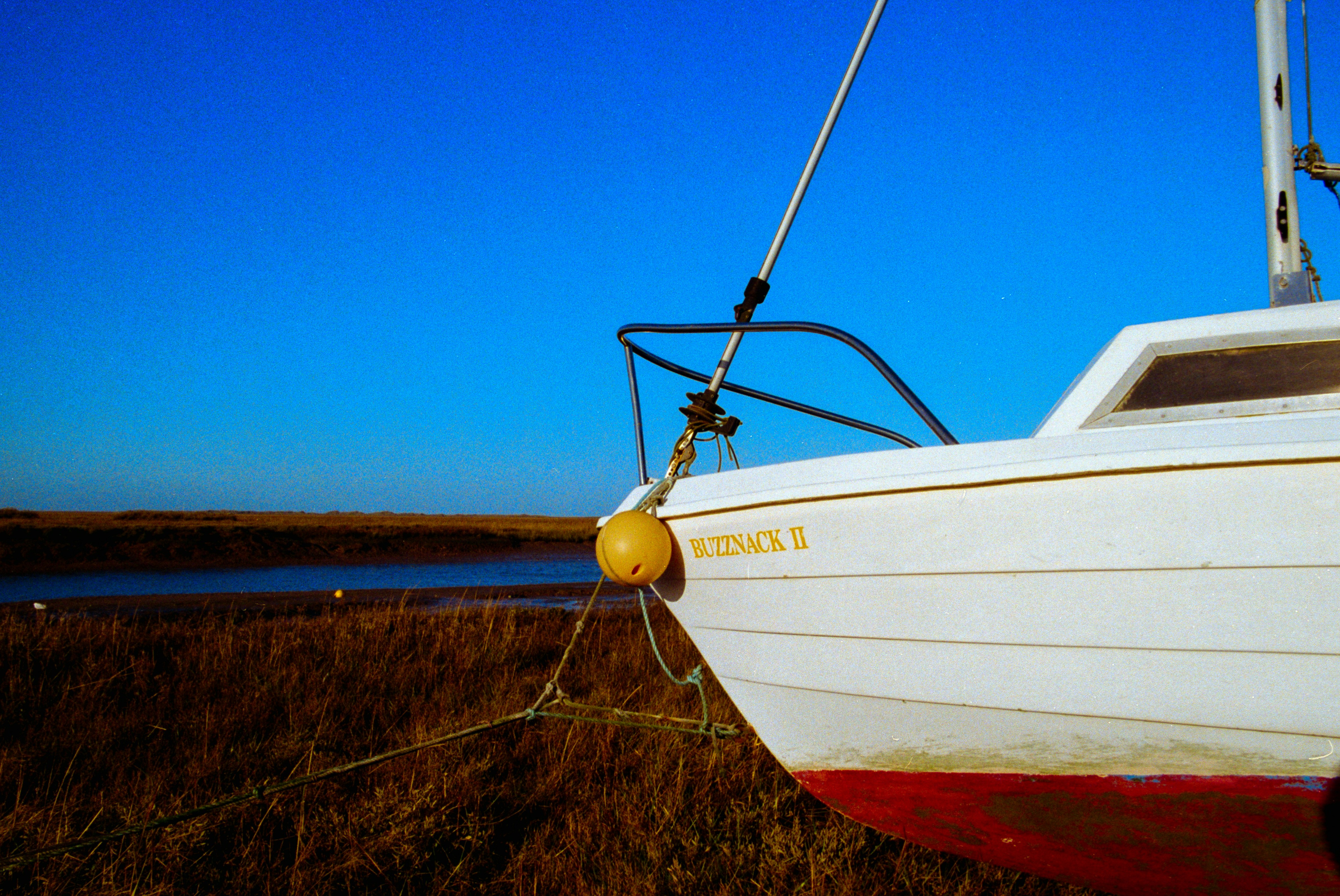 Hull at the Edge: A Quiet Harbor Boat Rest on Marshland