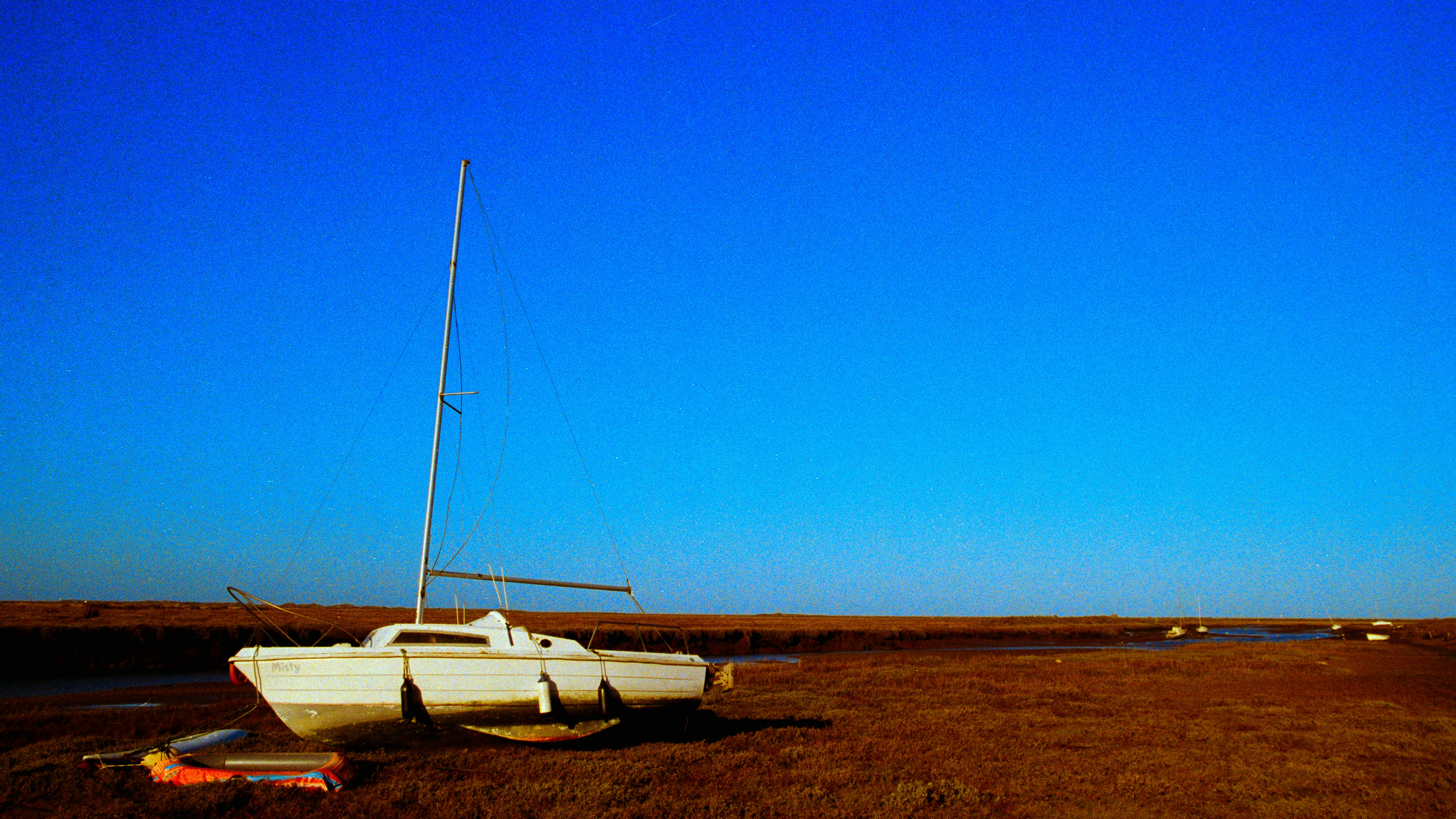 Low Tide by the Distant Shore: Boats Rest on a Quiet Plain