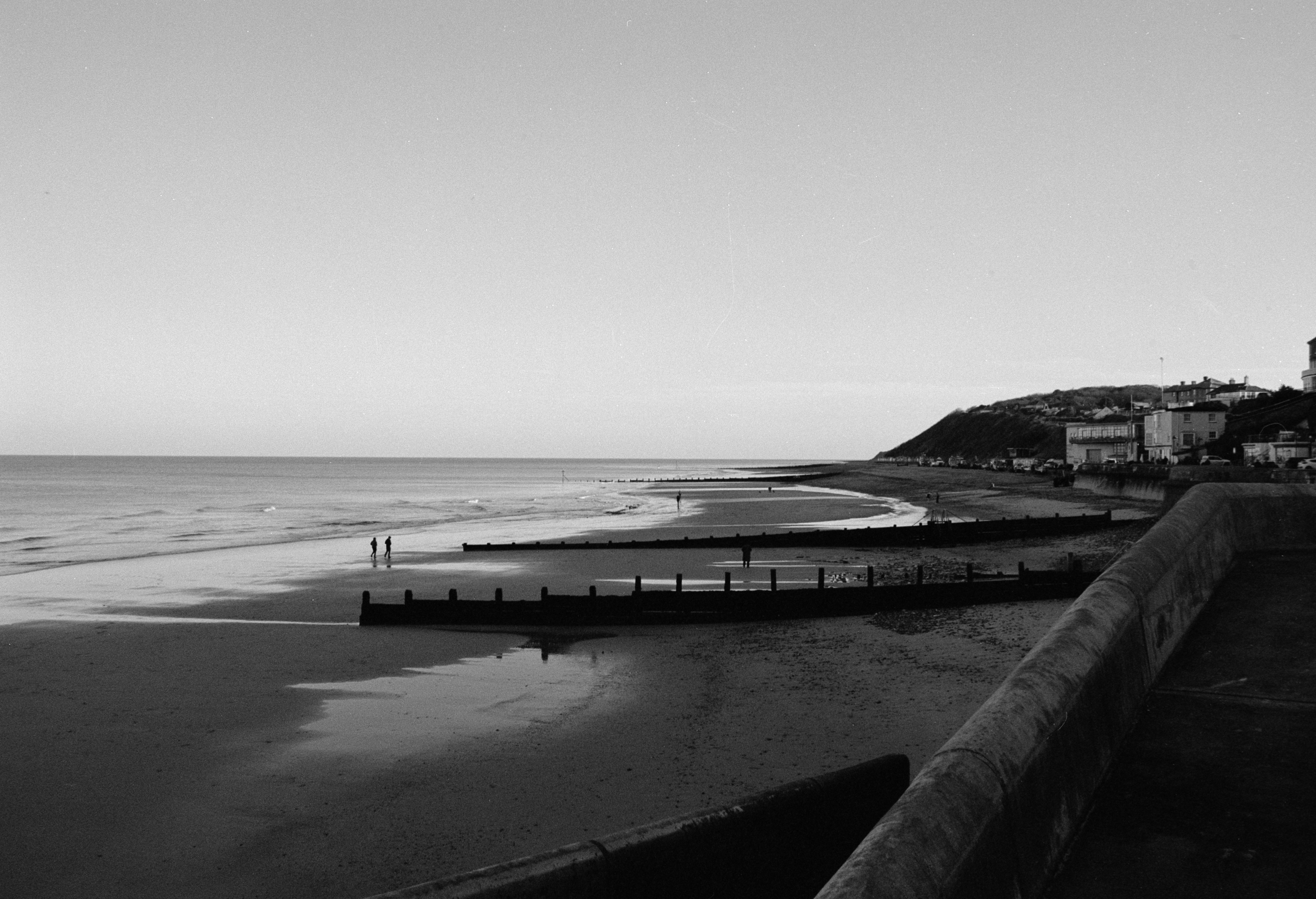 Coastline Twilight: A Quiet Shore Framed by a Sea Wall