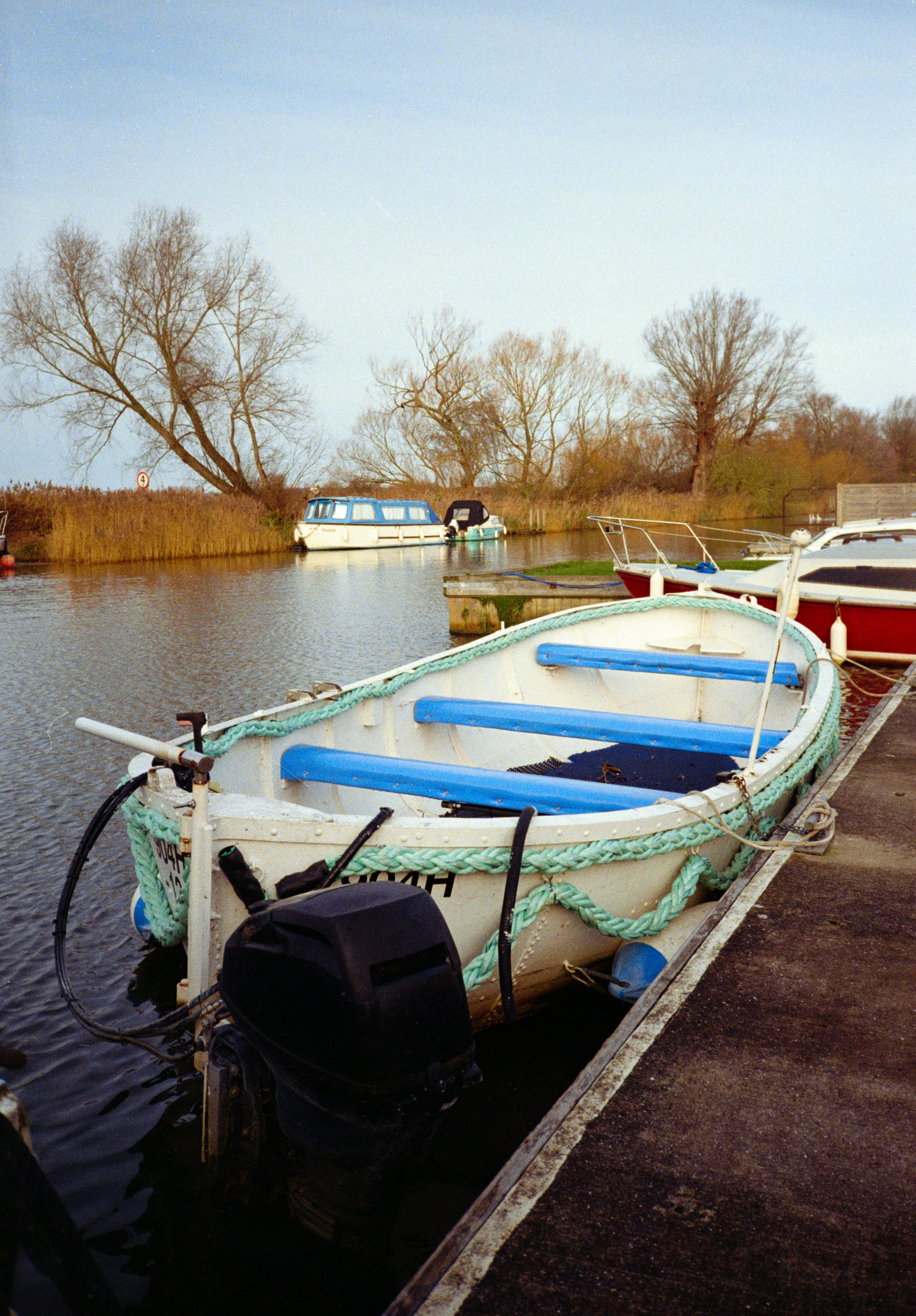 Docked Dream: A Row of Boats Resting by the Quiet Canal