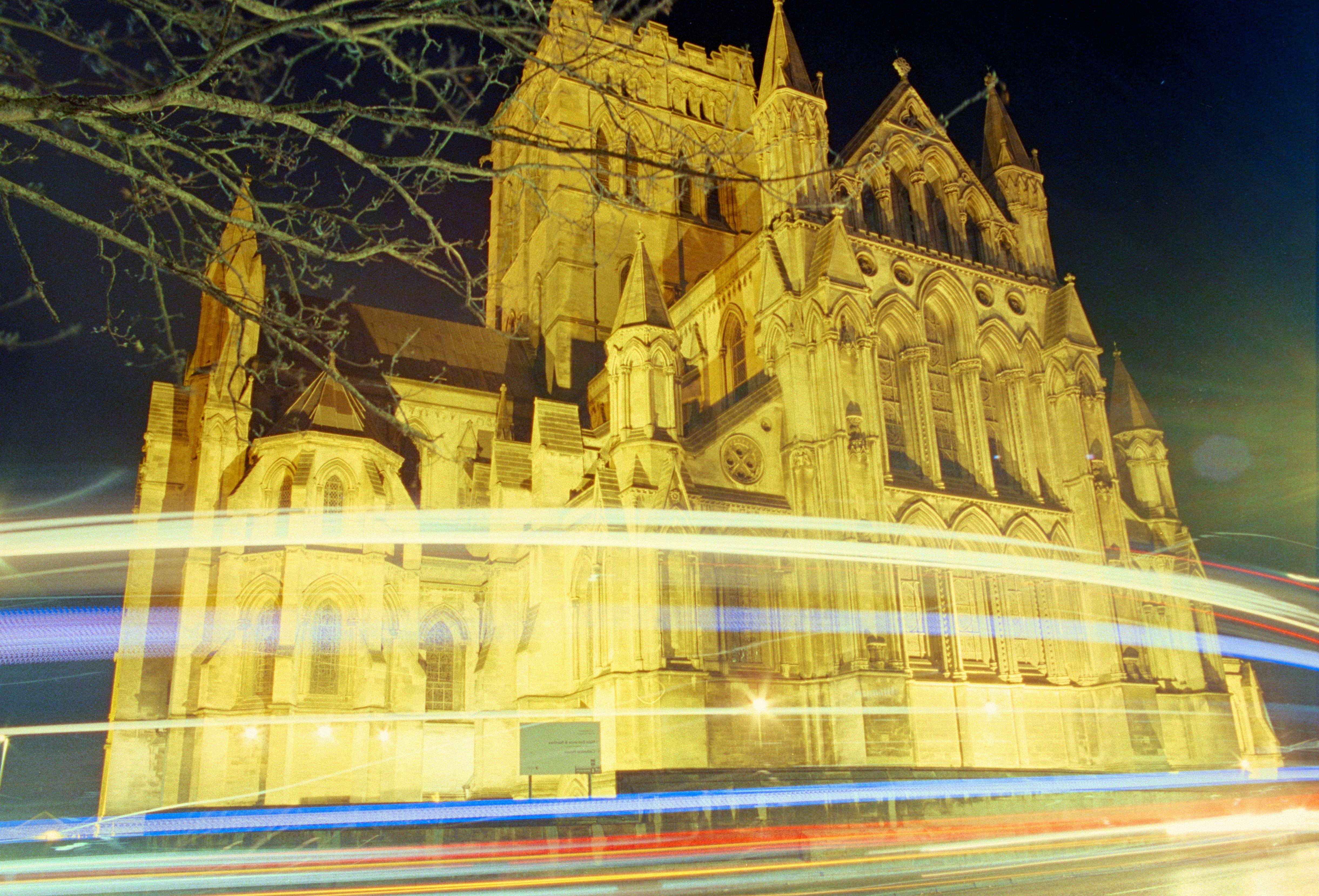 Gothic Cathedral in Transit: Light Trails Across Night Stone