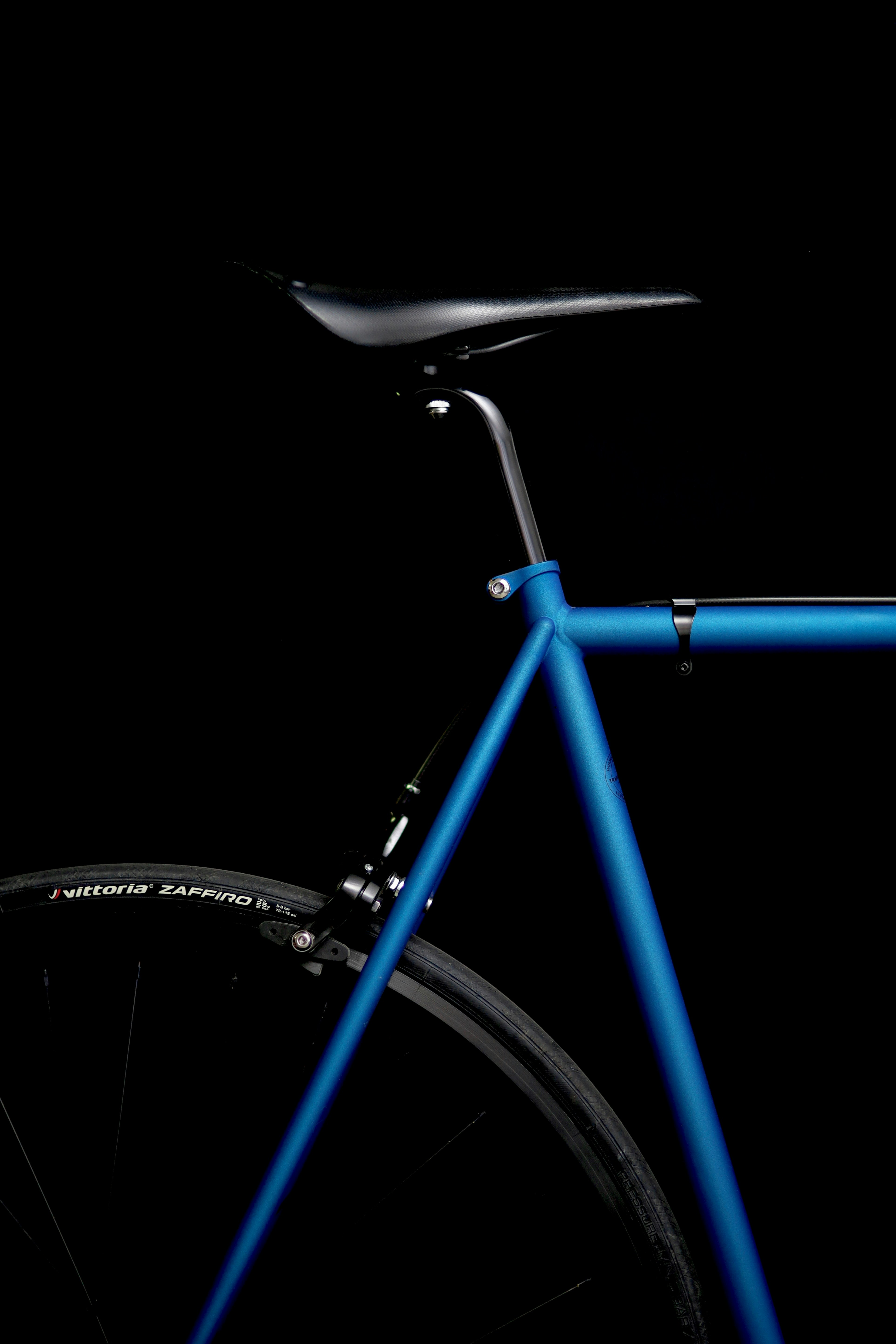 Blue Frame: A Bicycle Frame Emerging from Darkness