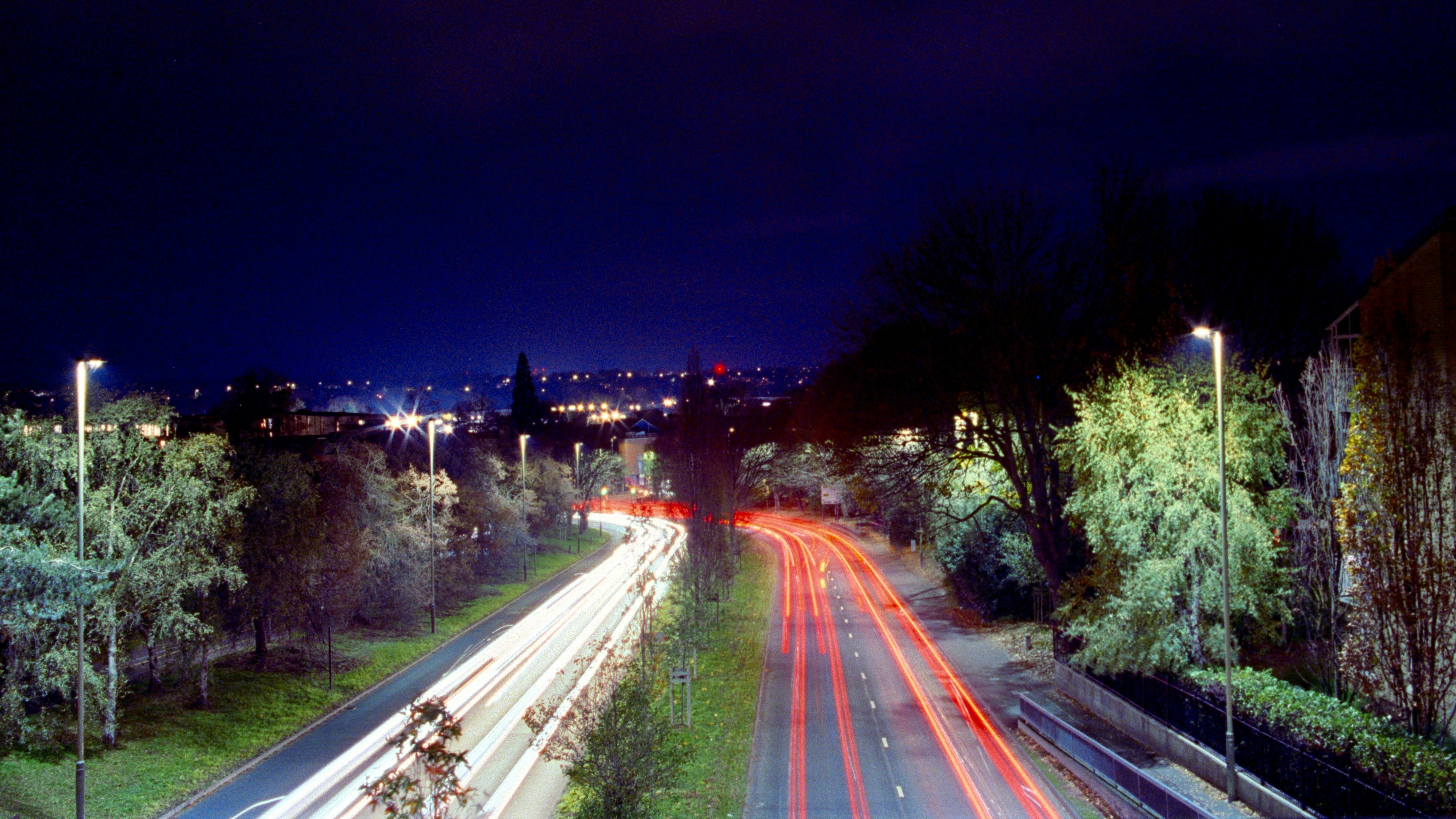 Evening Artery: Twin Trails of Light Through a Quiet City Lane
