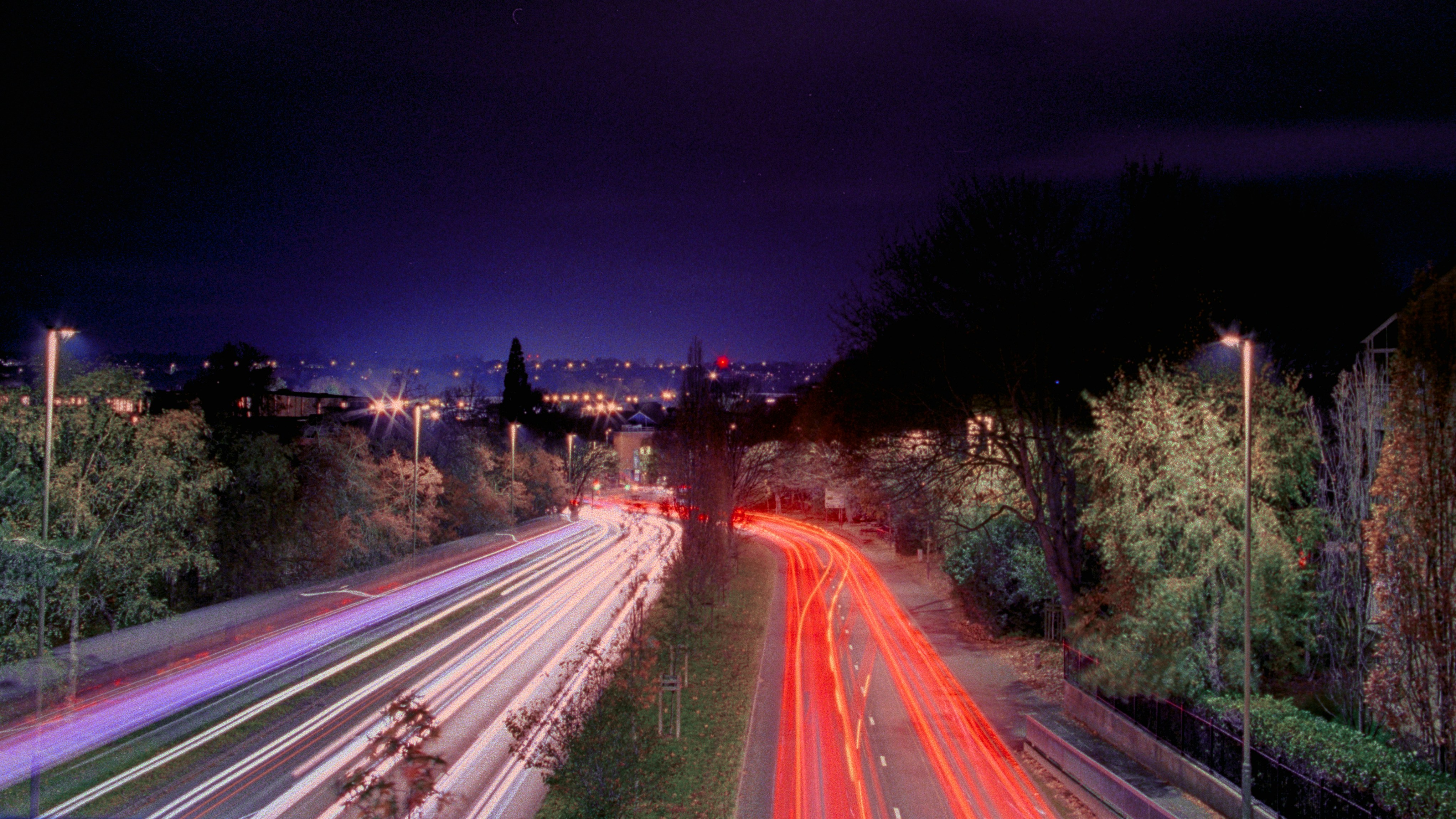 City Night Drive: Light Trails Converge Toward Quiet Horizon