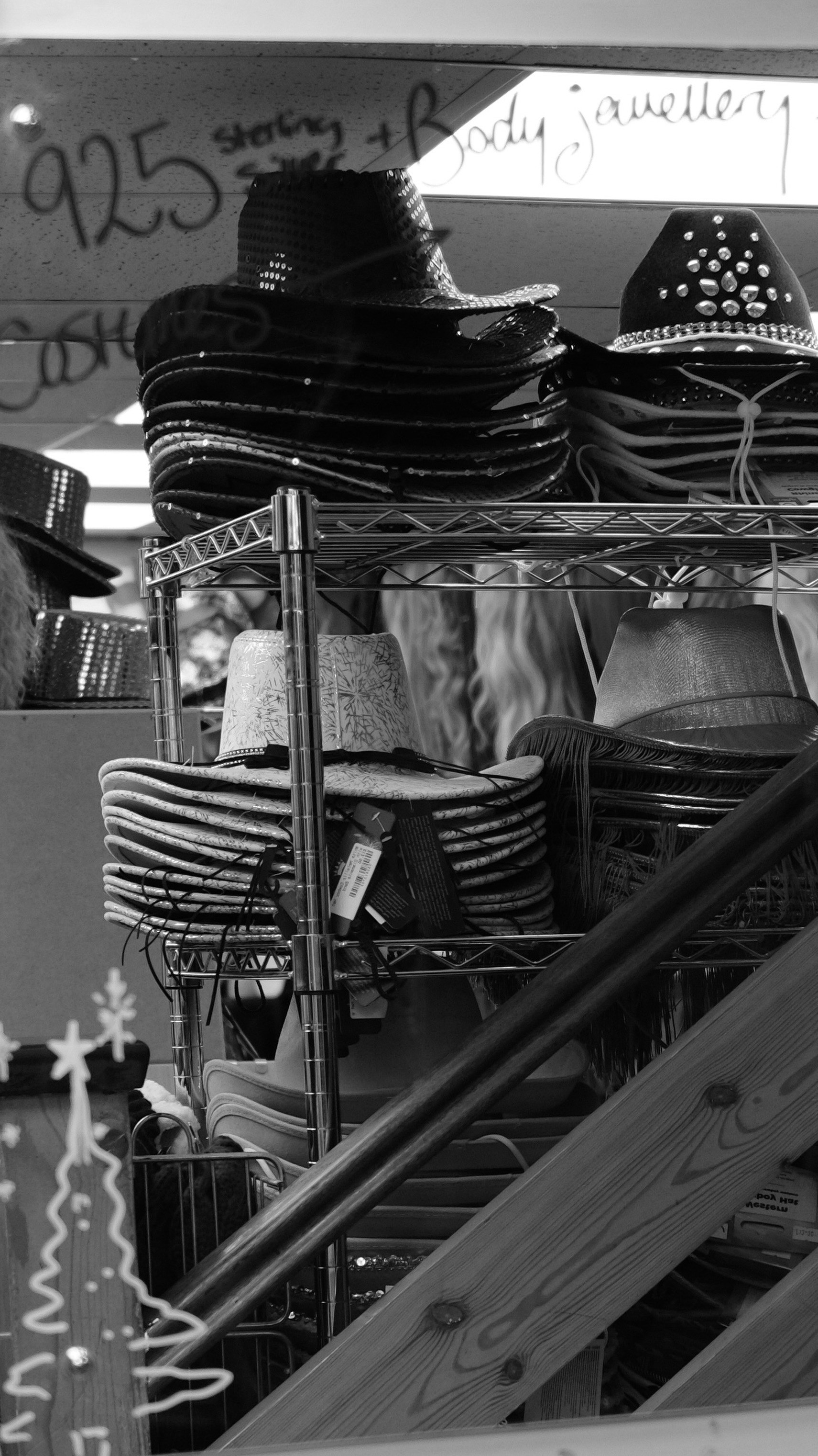 Stacked Hats and Wireframe Echoes in a Quiet Shop