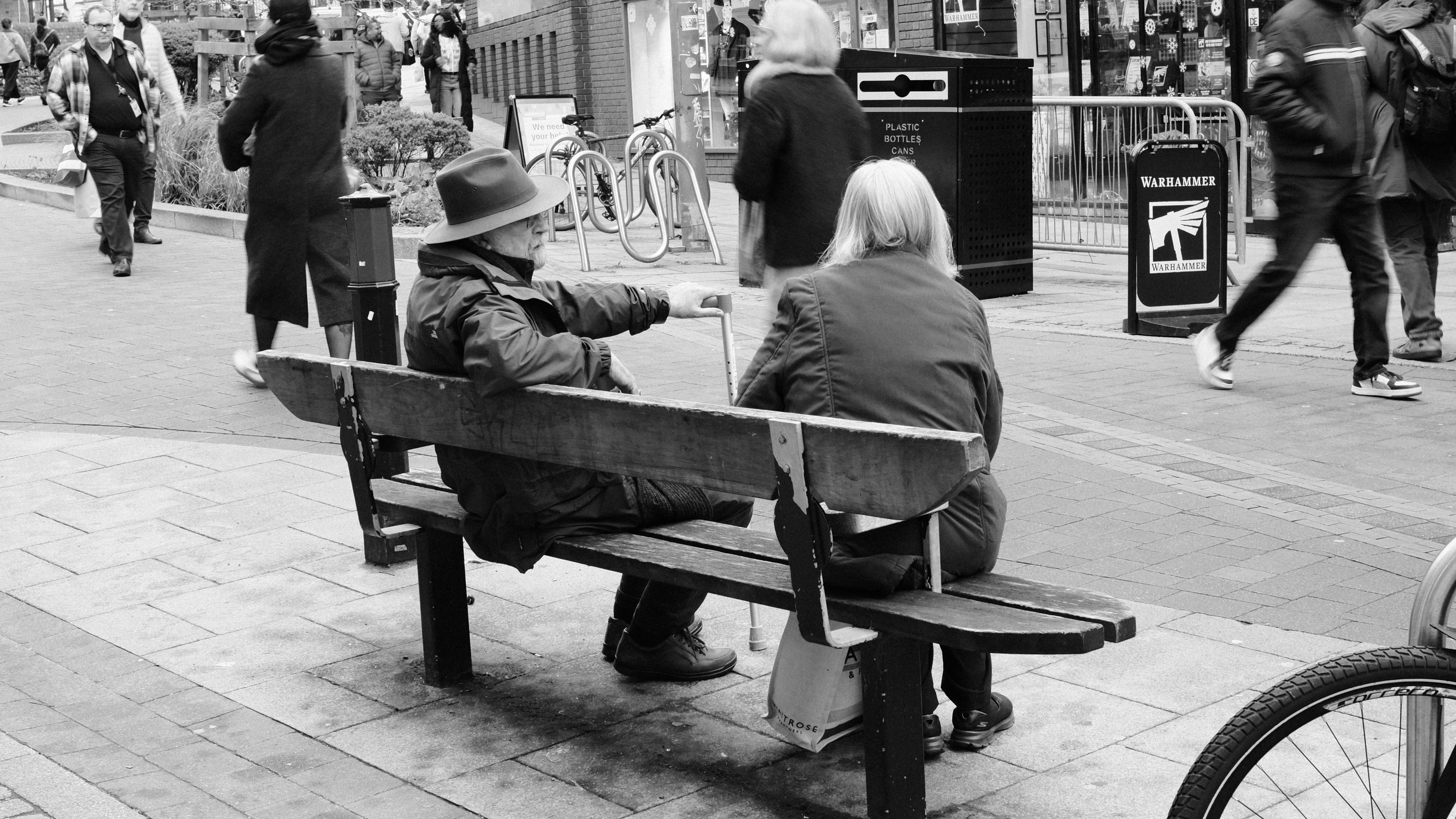 Paused Conversation on a City Bench