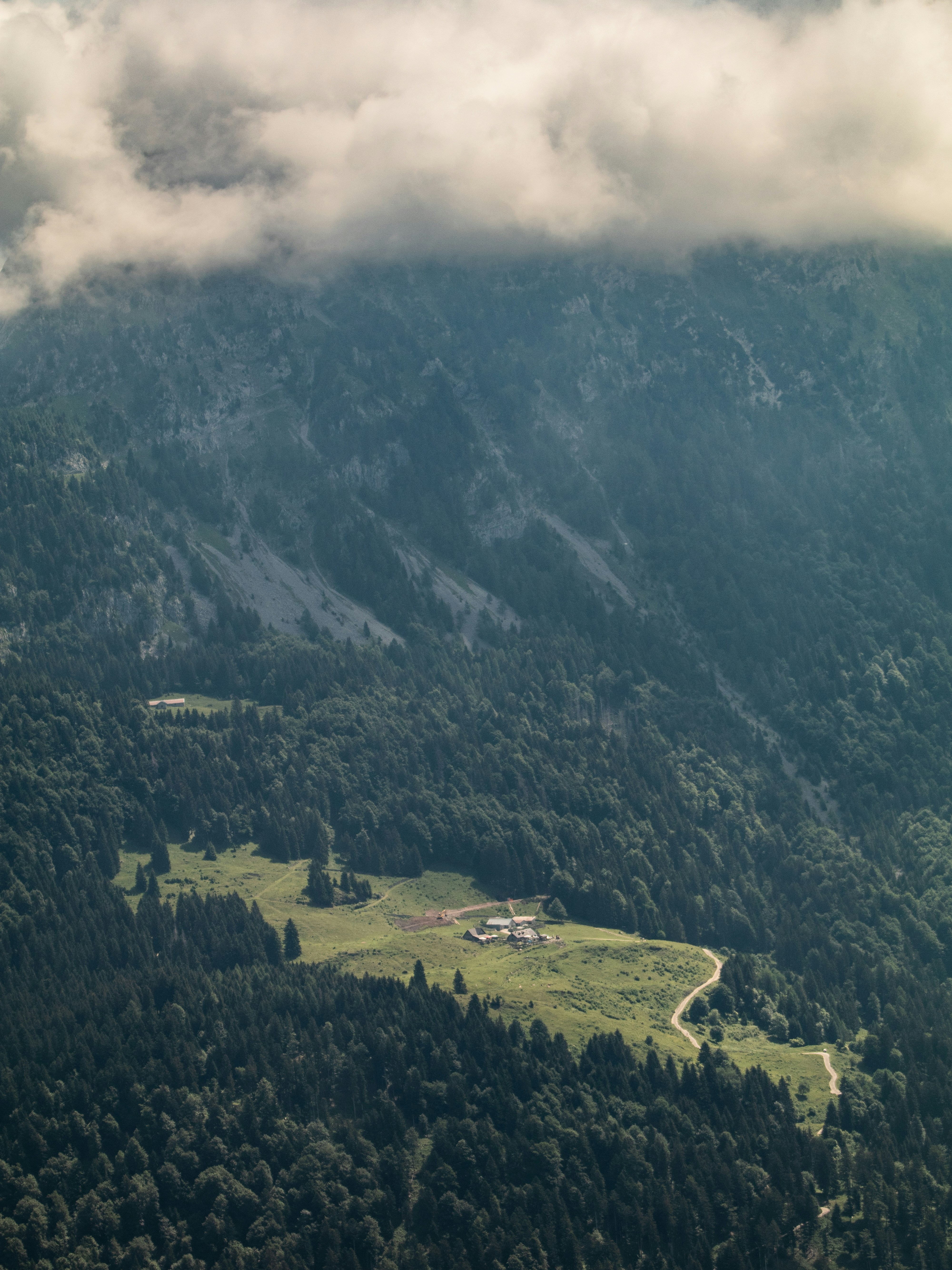 Mountain Farmstead Beneath a Cloud-veiled Ridge