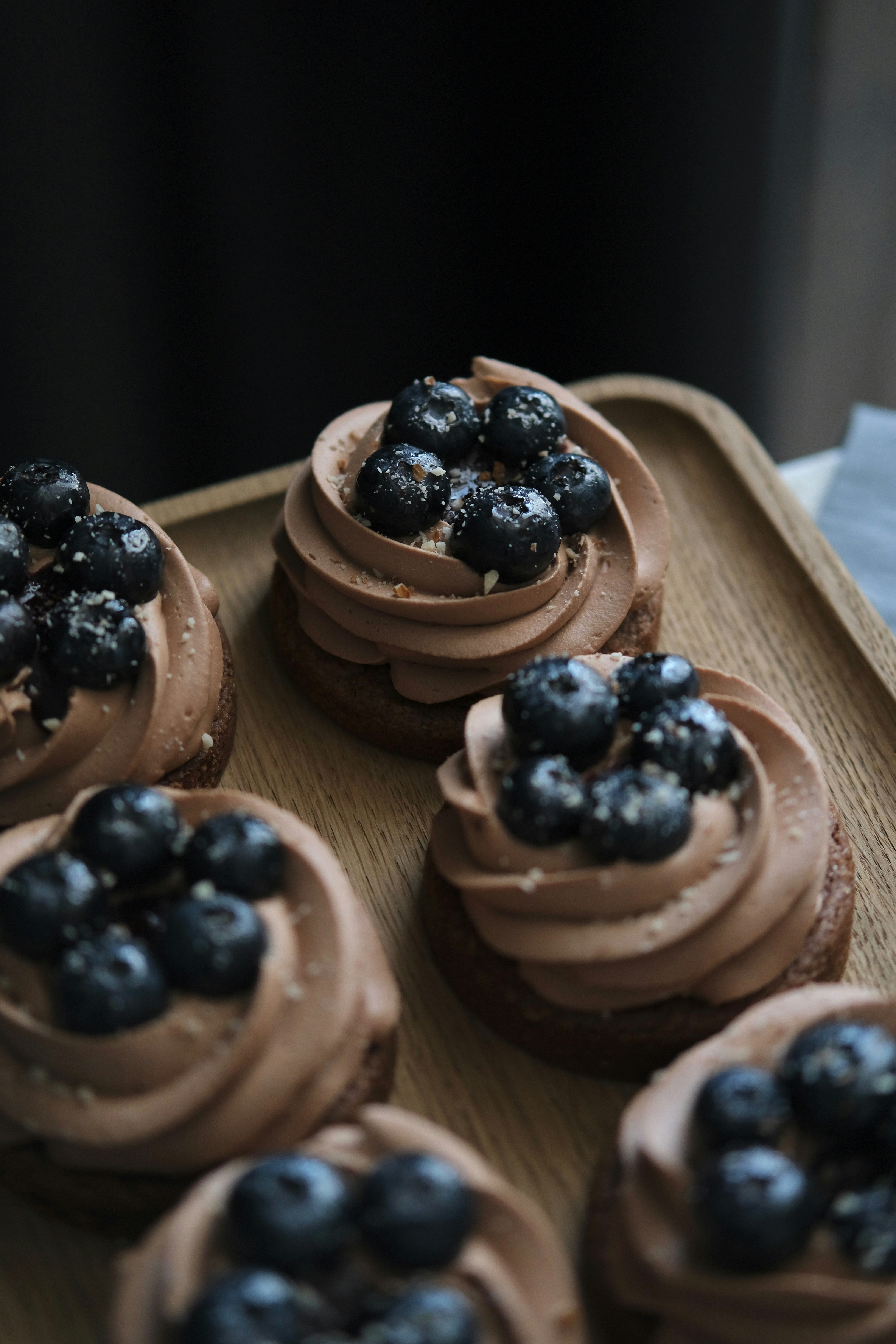 Chocolate Swirl Cakes with Blueberry Crown on a Rustic Tray