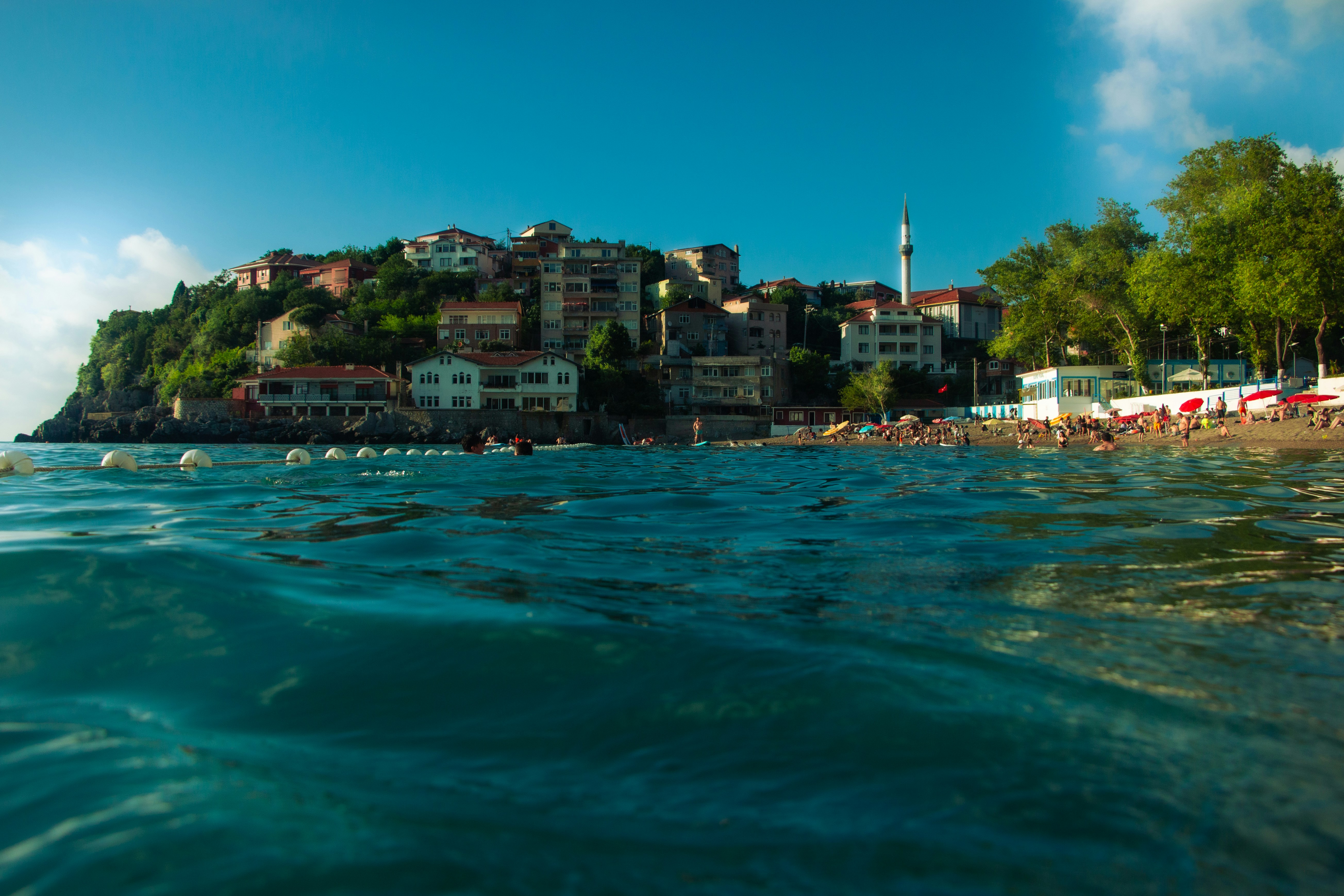 Ridge of colorful houses overlooking a sunlit Adriatic inlet