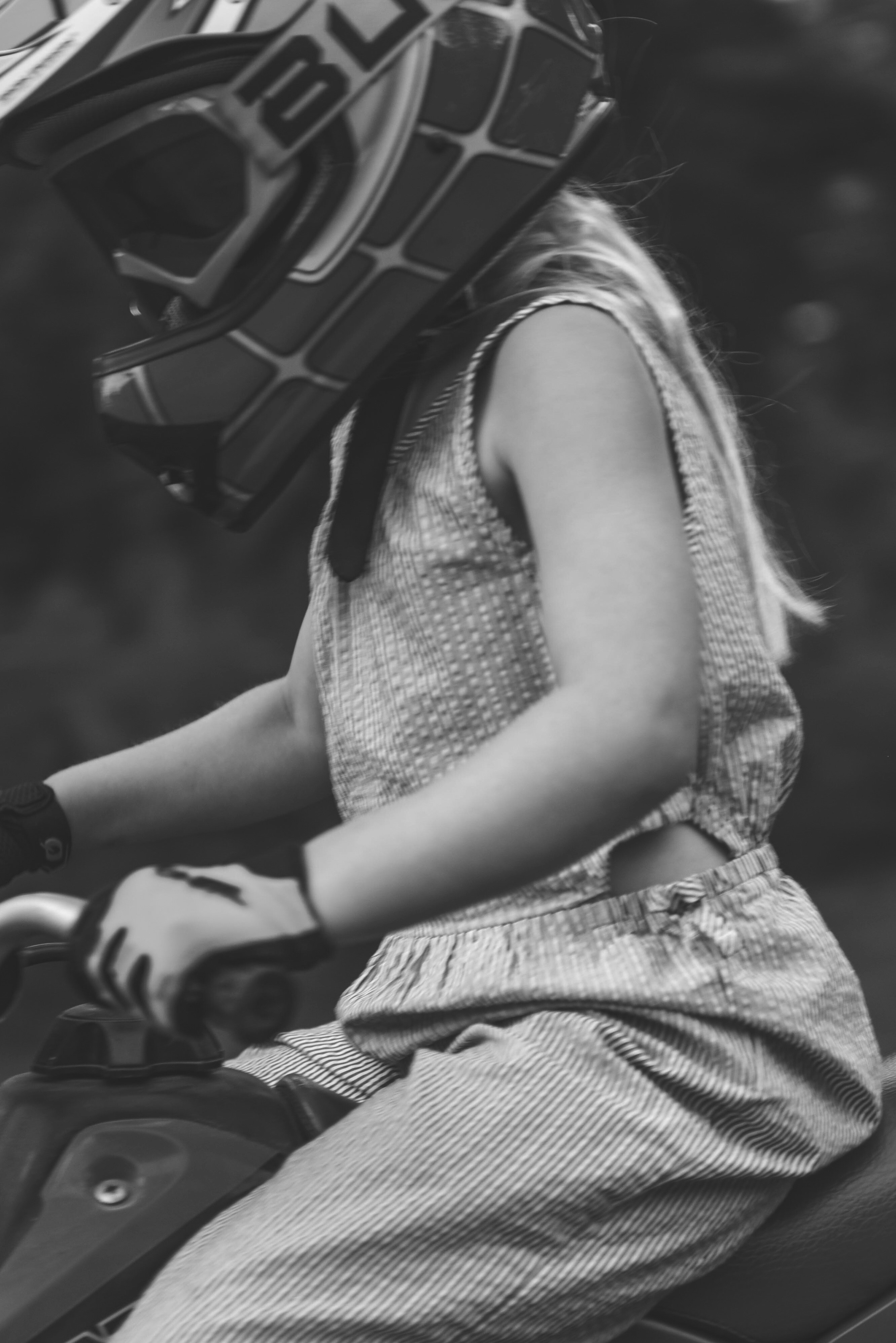 Helmeted Rider in Motion: A Child on a Motorcycle