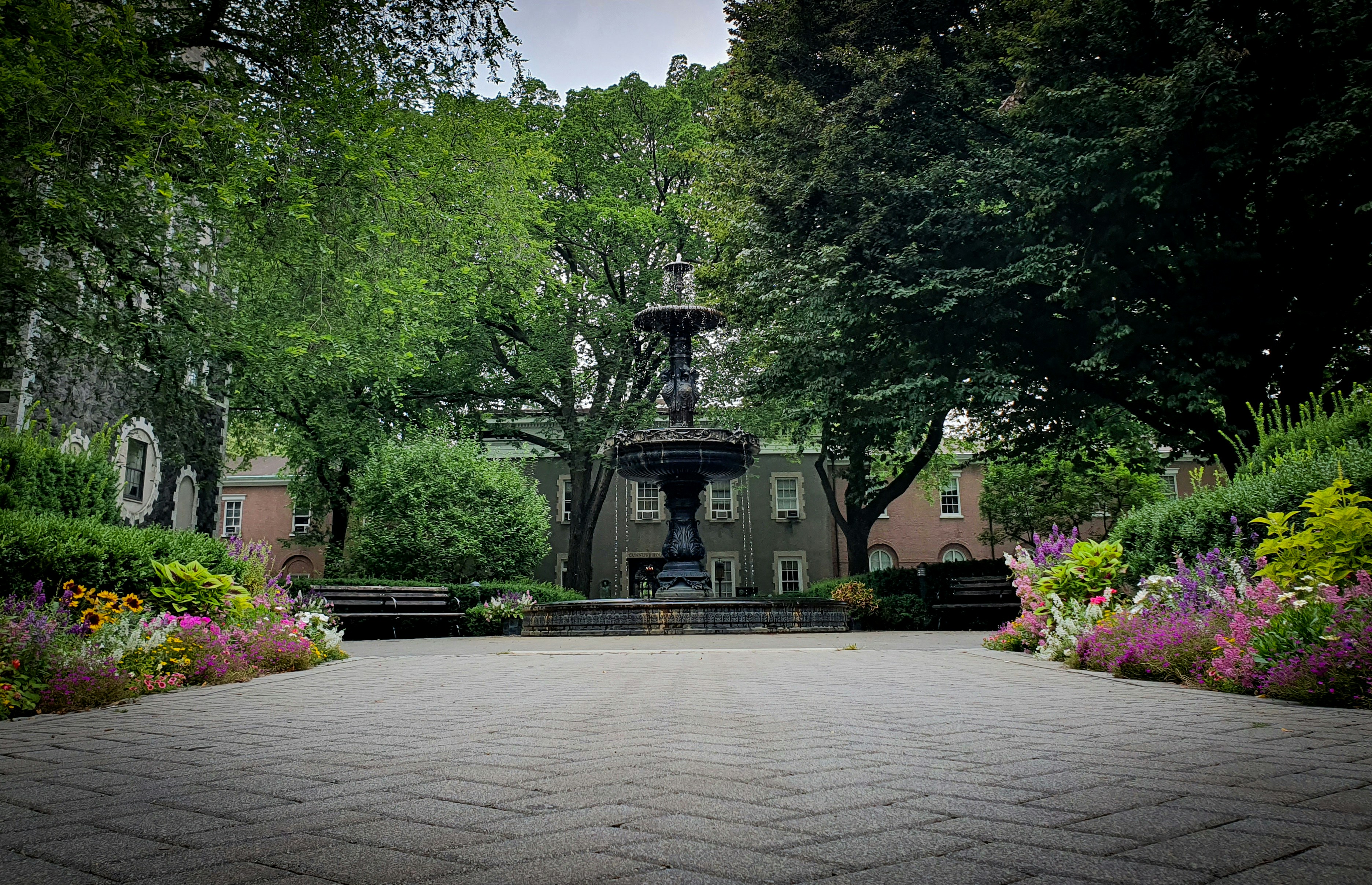 Symmetrical Courtyard Fountain Framed by Greenery