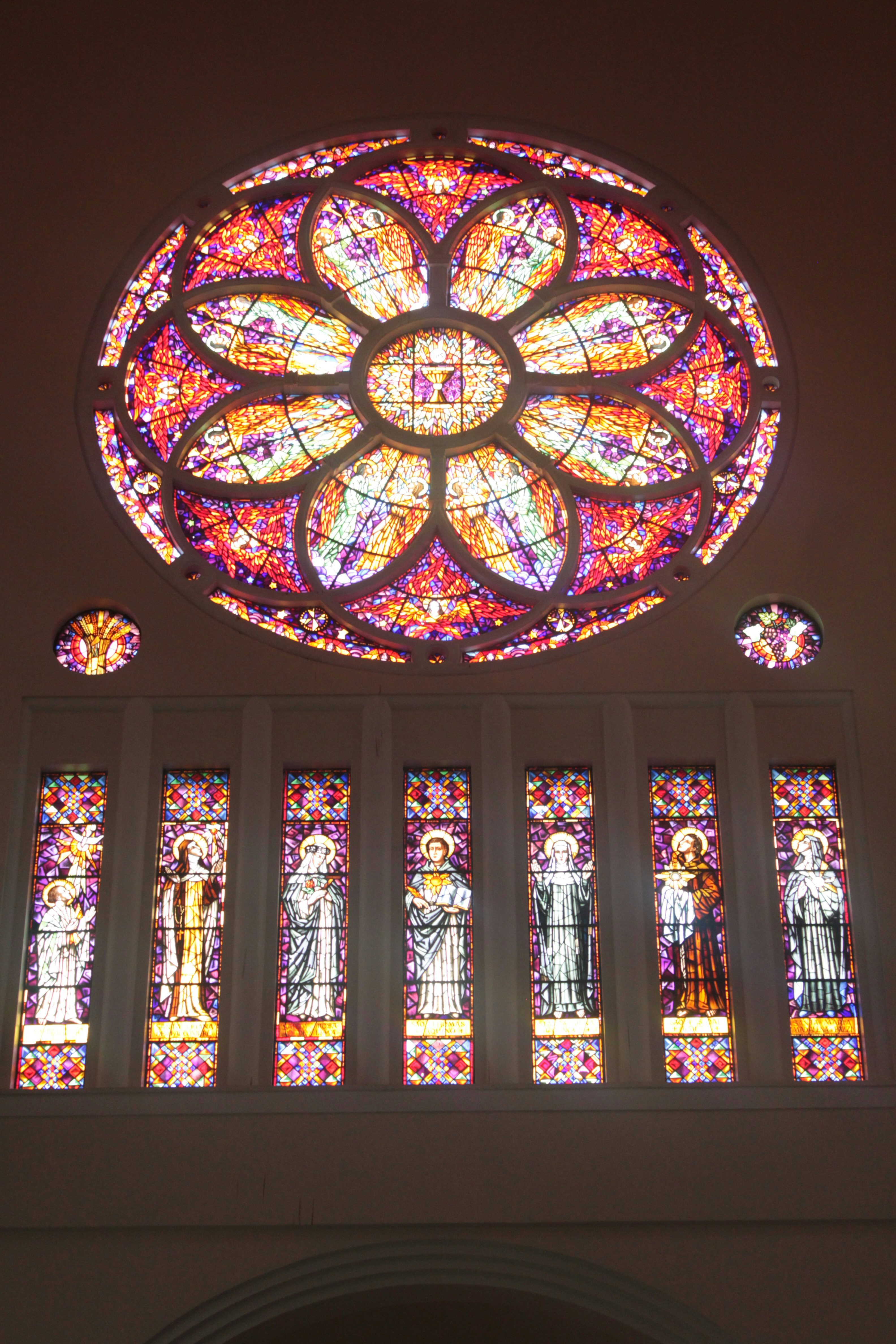 Circular Rose Window Over a Row of Stained Glass Panels