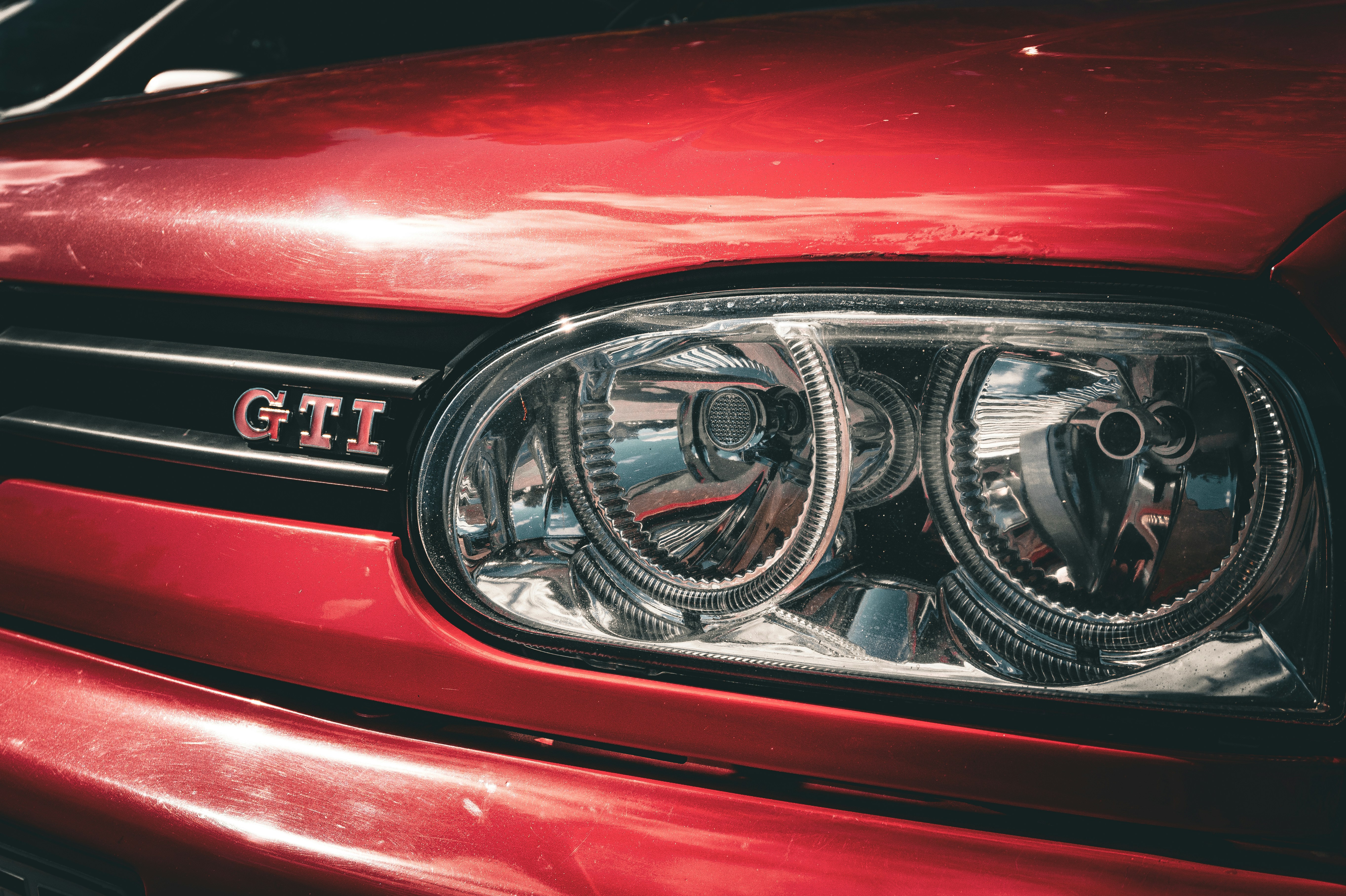 Red GTI Precision: A close-up of the classic headlamp and badge