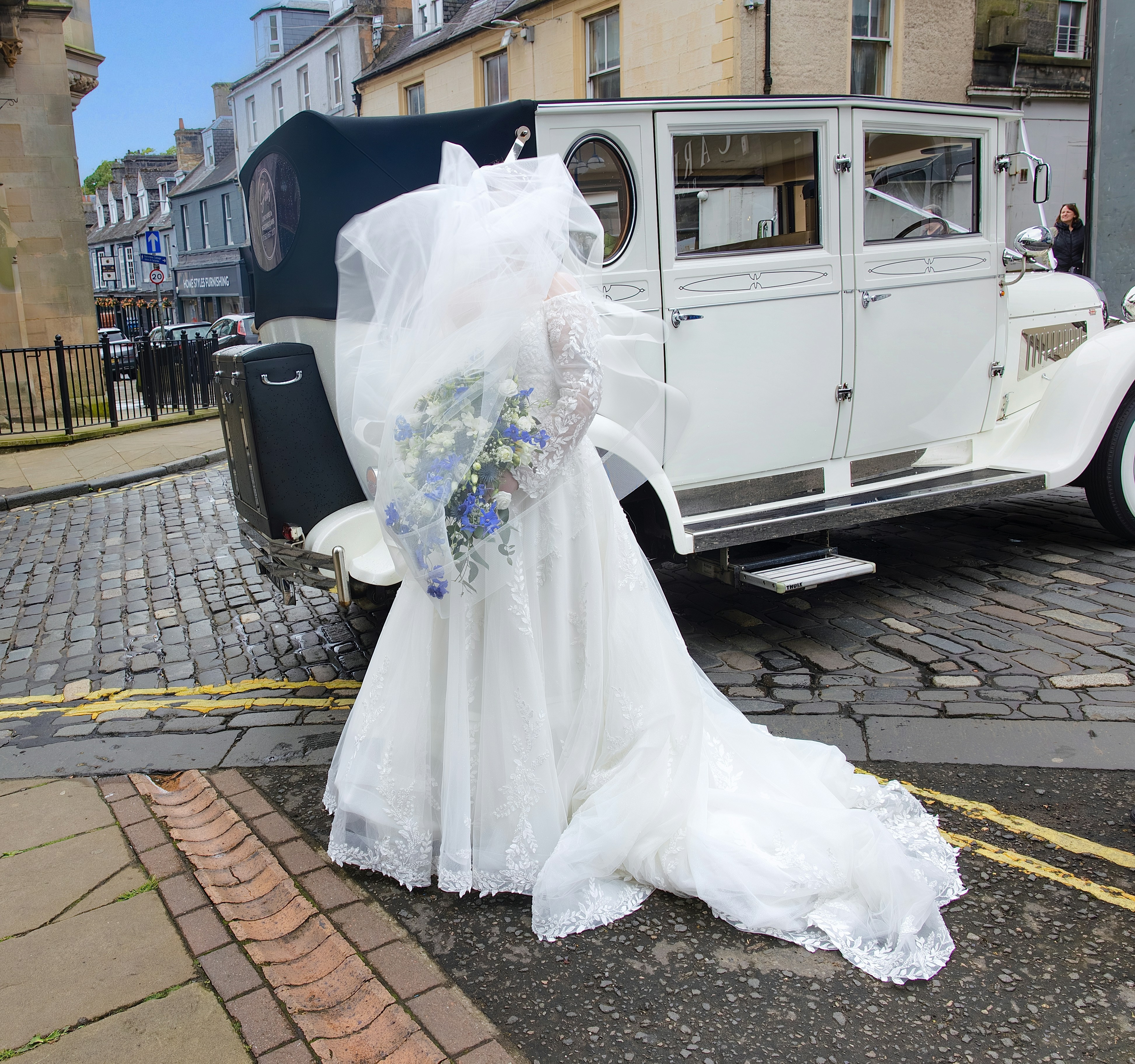 Bride in White with Vintage Car on Cobbled Street