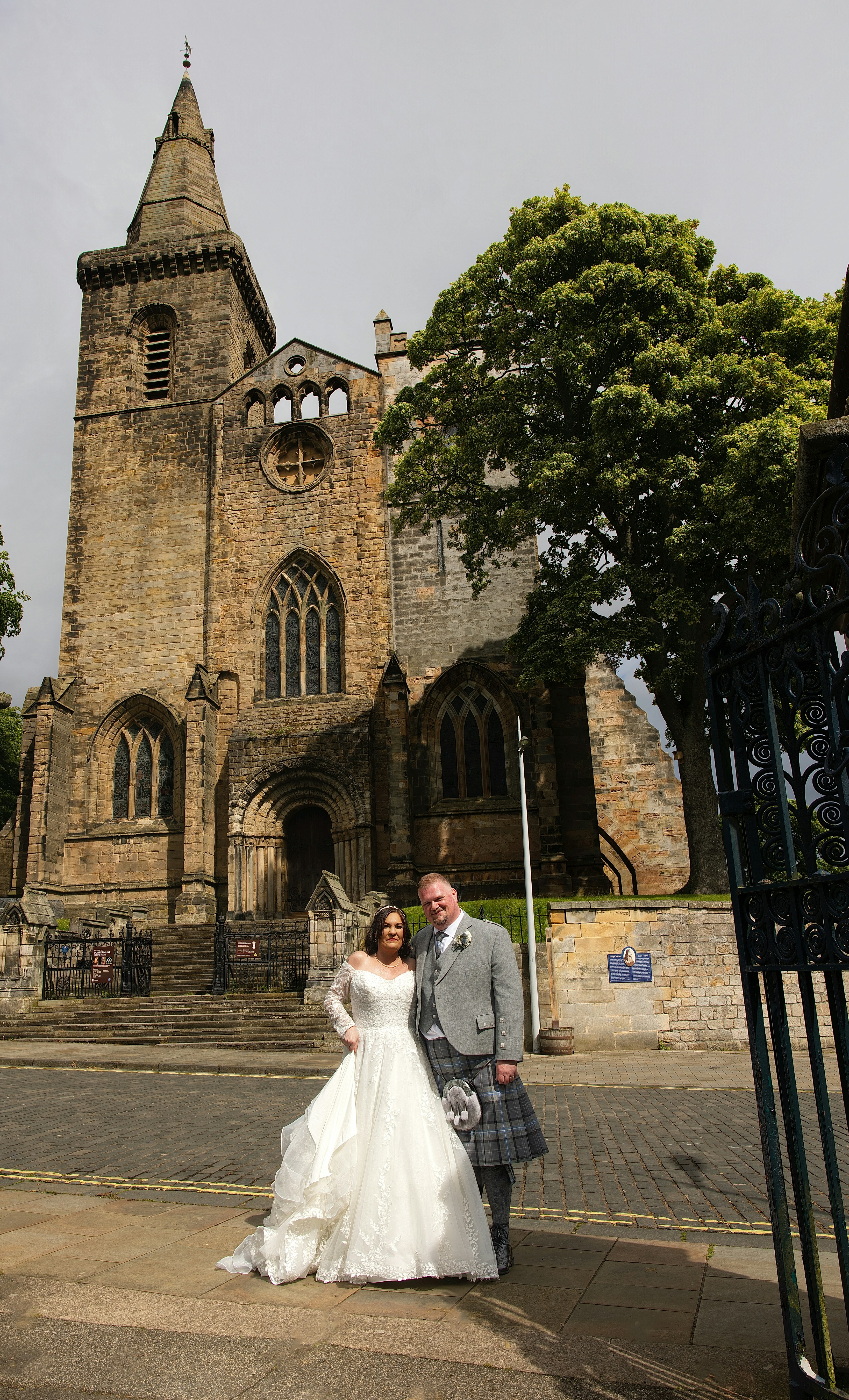 Bridal Couple at the Threshold of a Stone Cathedral